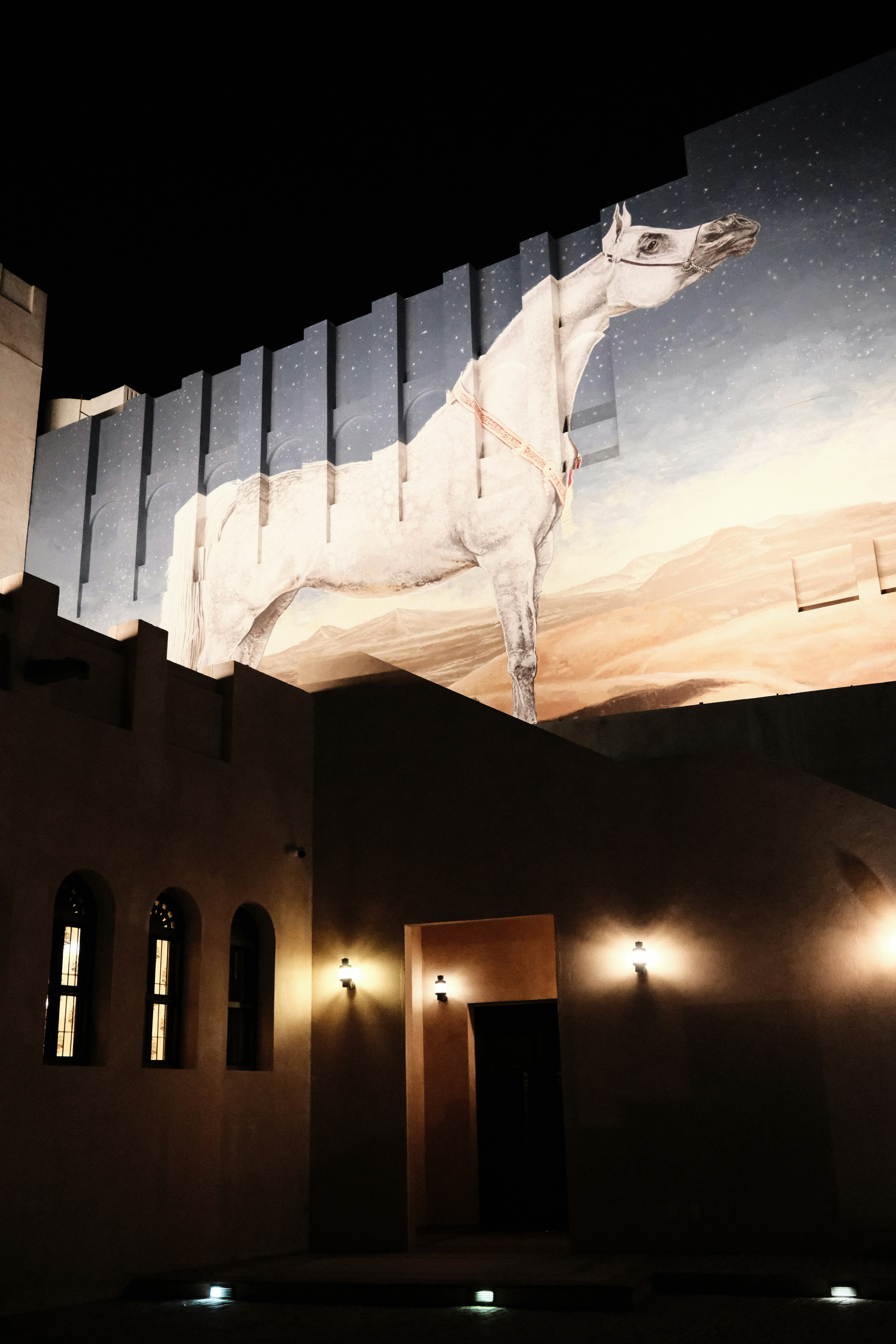 Desert Horse Mural Spanning Upstairs: Night Gallery with Dim Lanterns