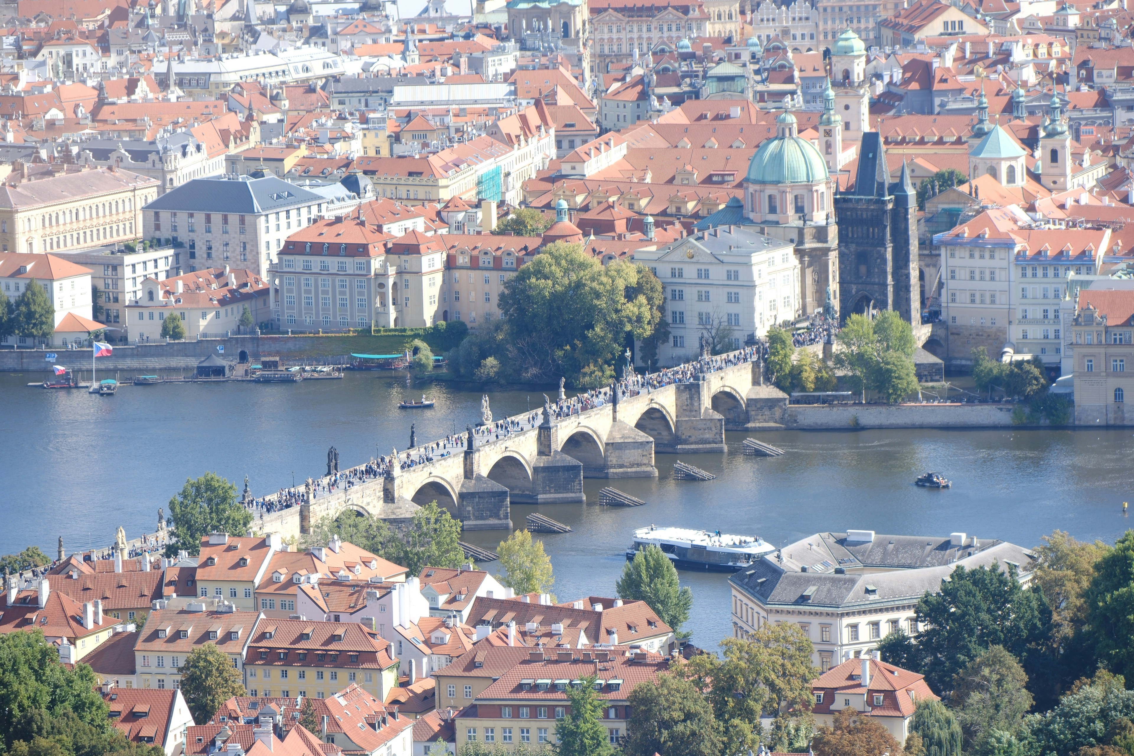 Riverside Arc: The Historic Bridge Framing Prague-style Rooftops