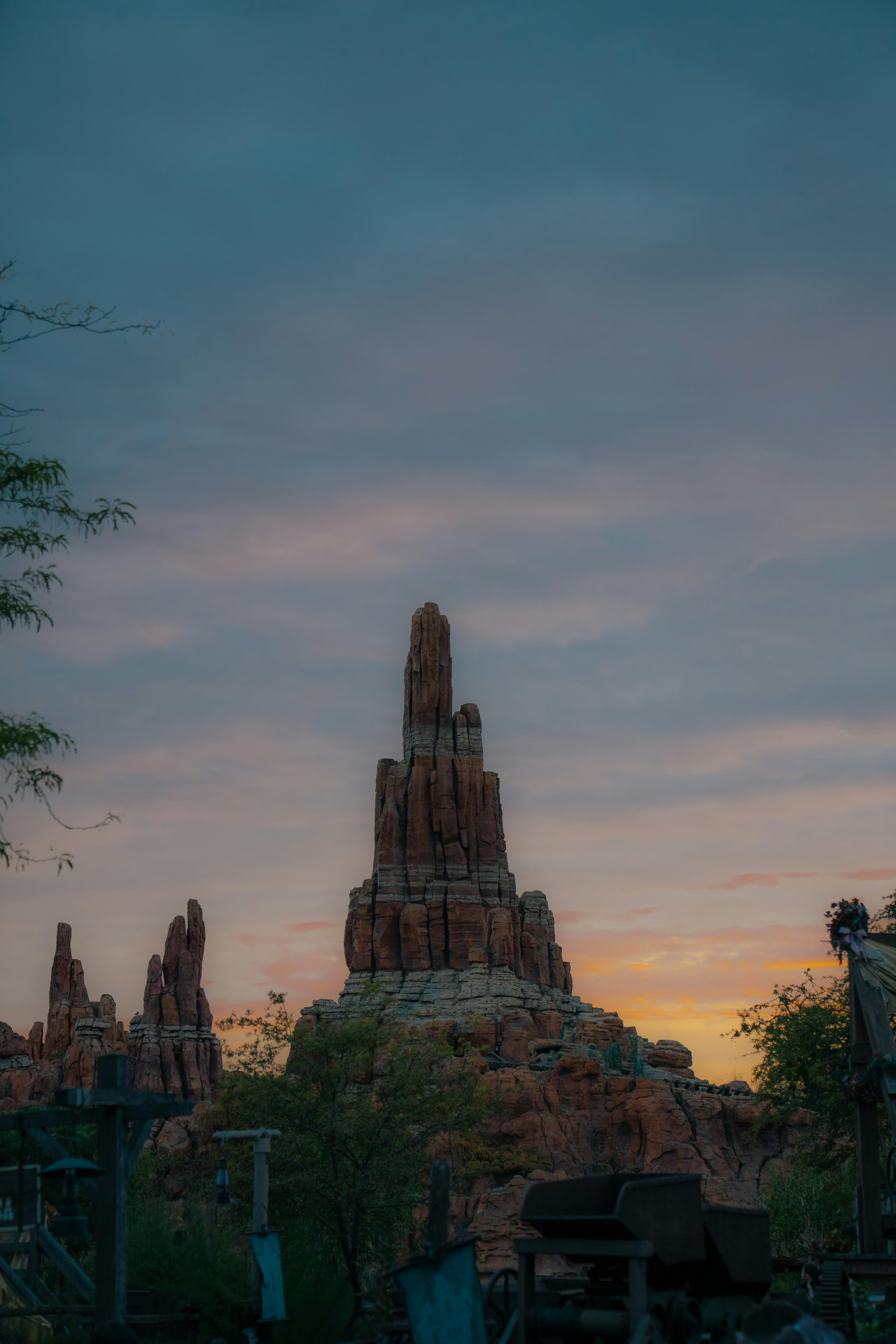 Desert Monument at Dusk: A towering sandstone pinnacle rising above rugged foreground