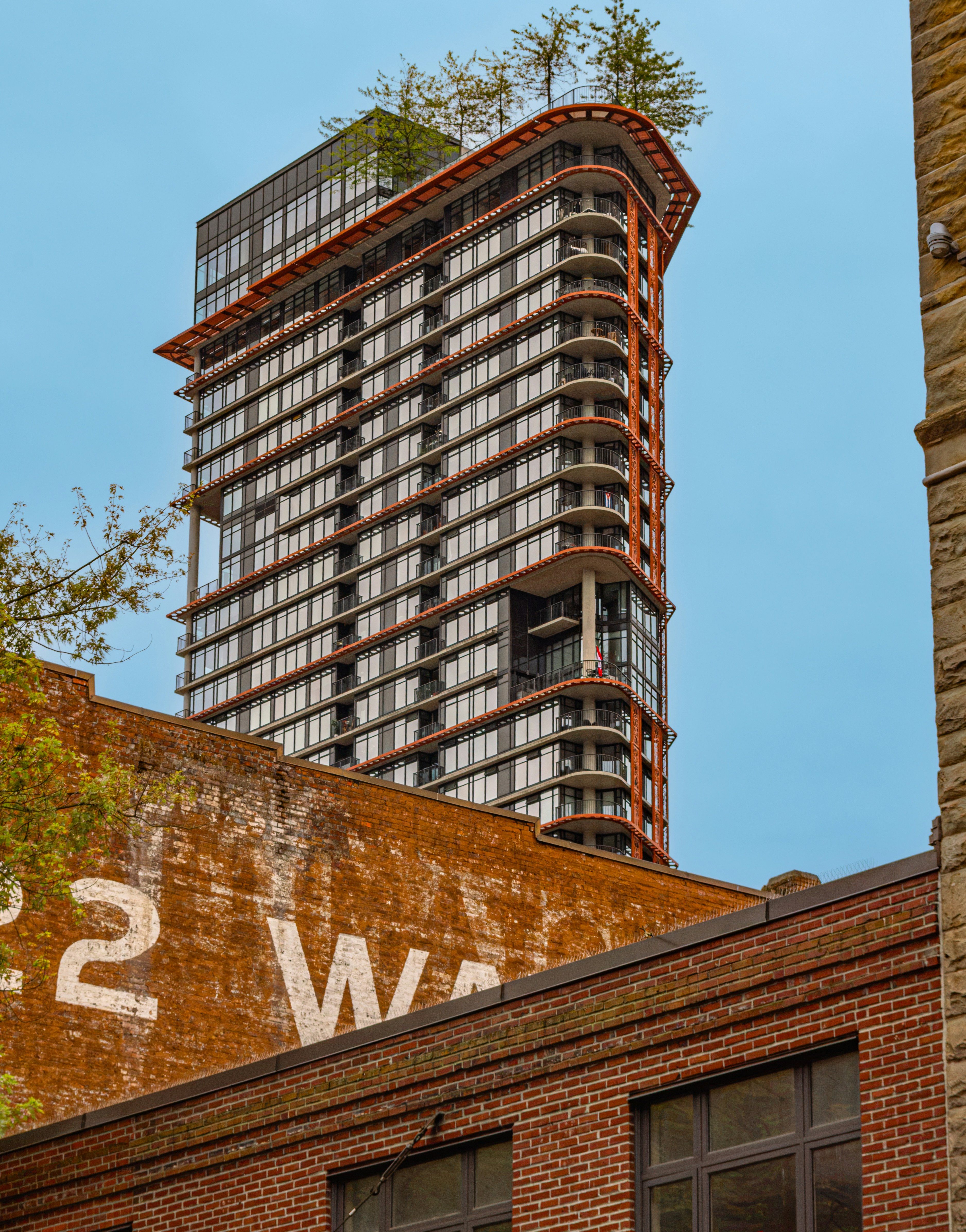 Vertical Fortitude: The Mixed-Use Tower Rising Over a Weathered Brick Base