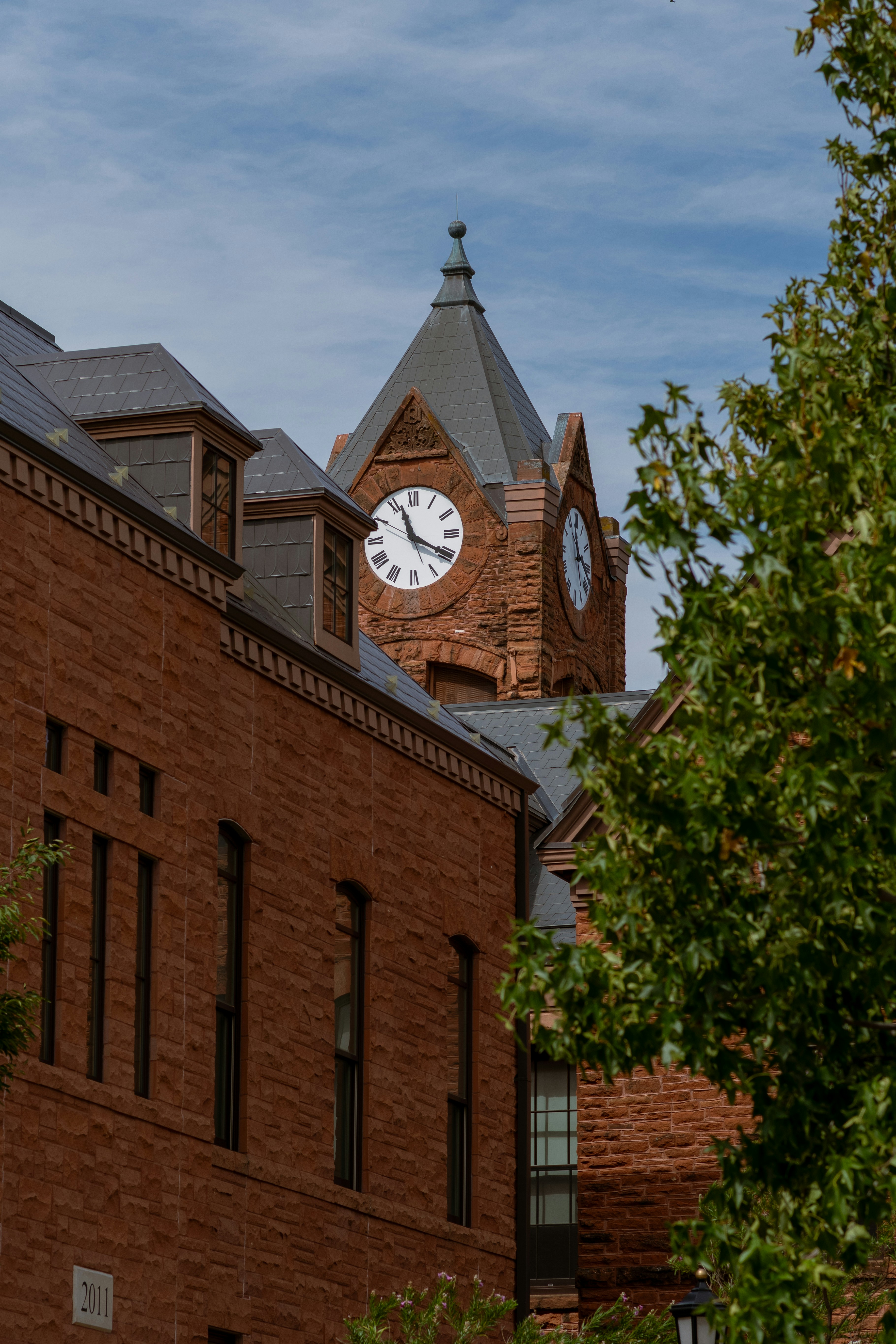 Brick Clocktower Rising Over Rooftops