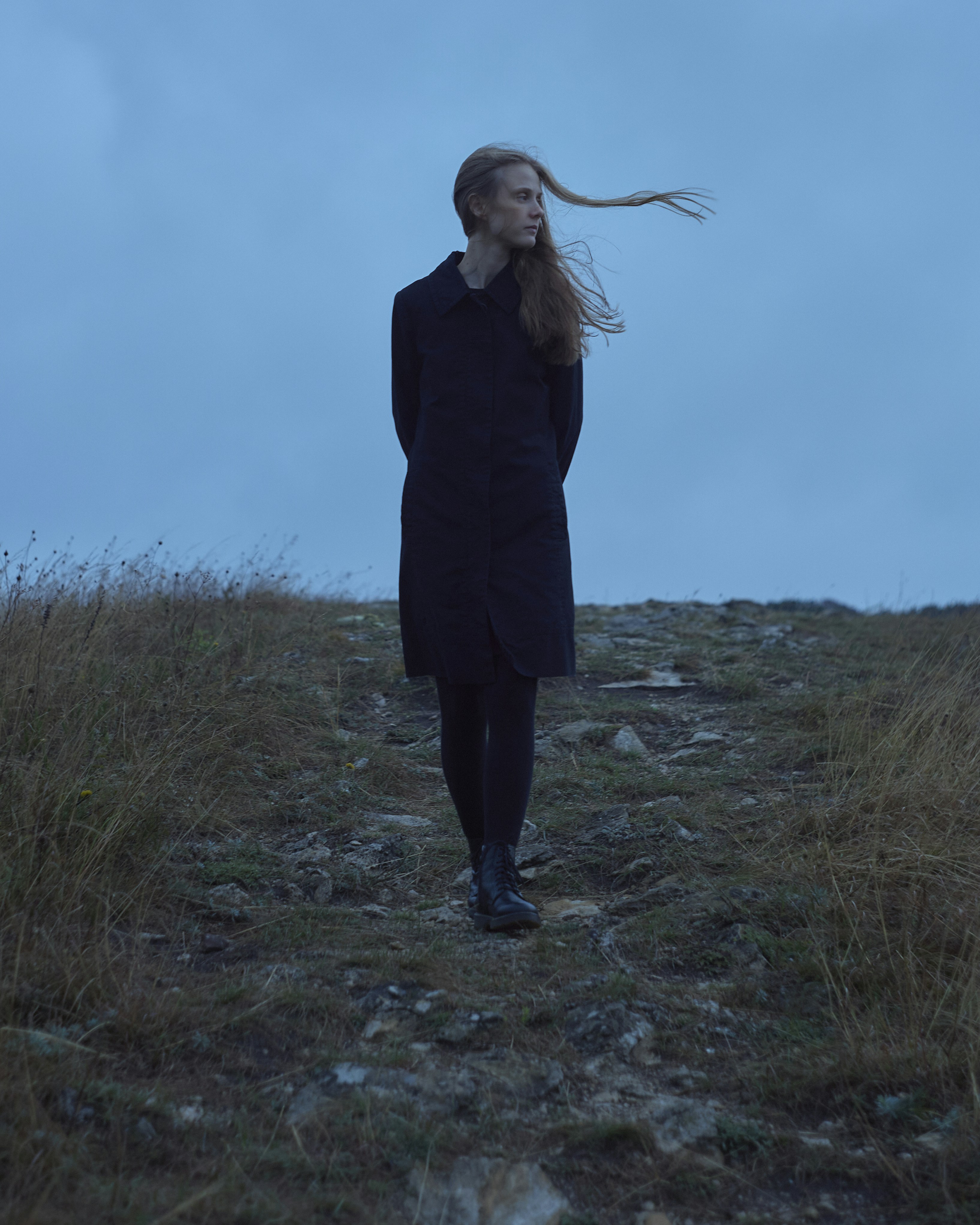 Windward Silhouette: A solitary figure on a windswept ridge