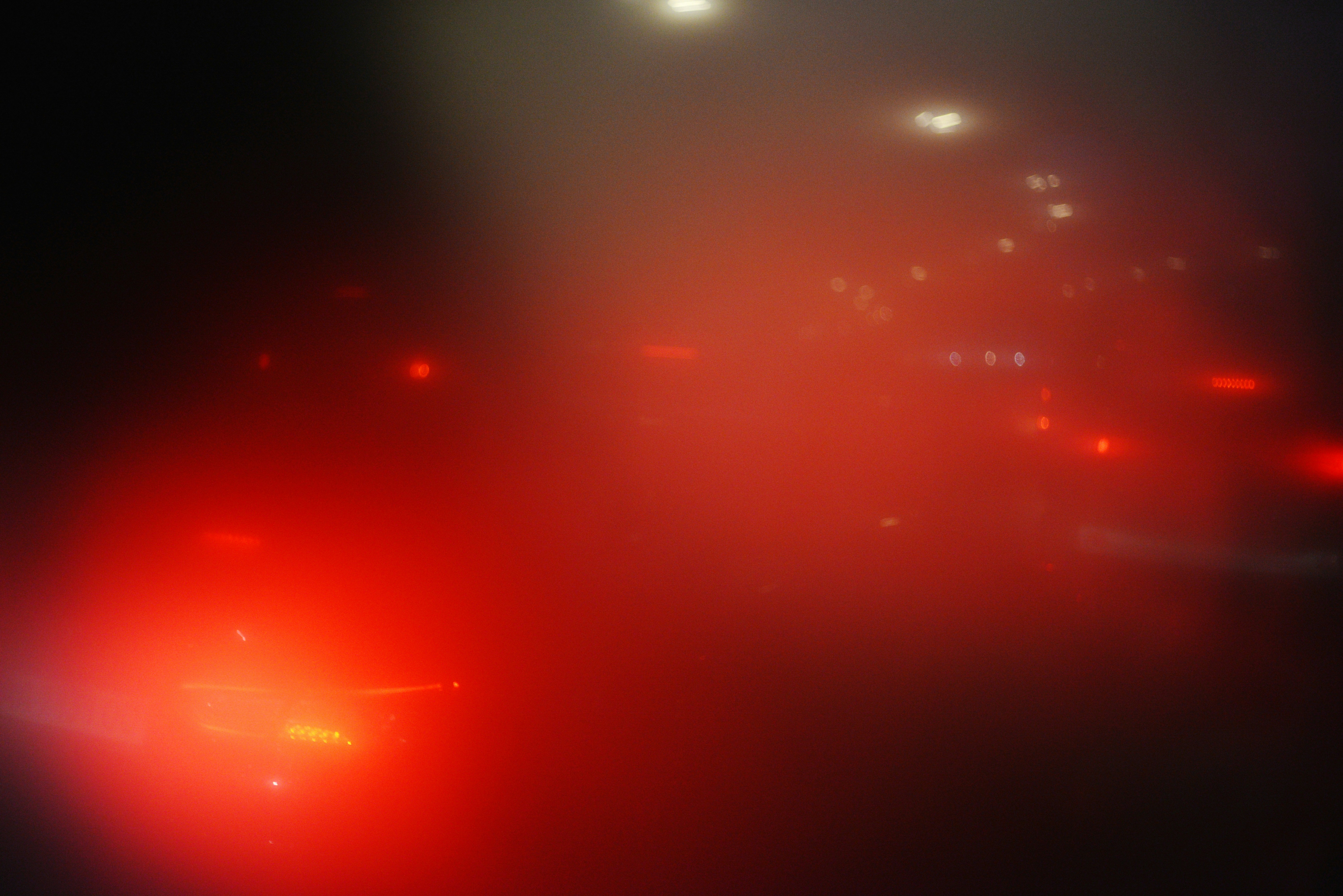 Crimson Motion: A Blurred Night of Distant Lights