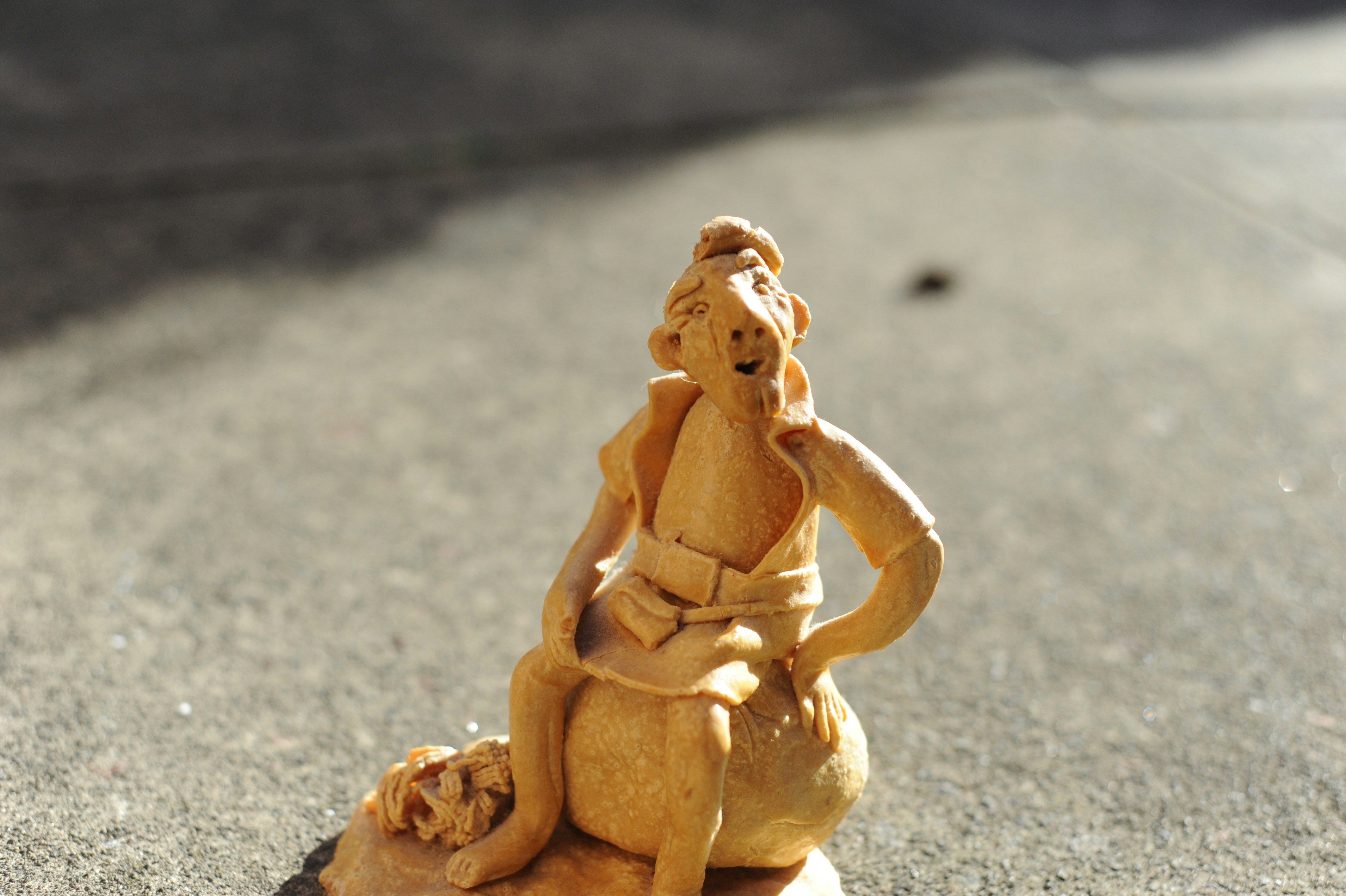 Sitting Sand Sculpture of a Woman with a Small Tiger
