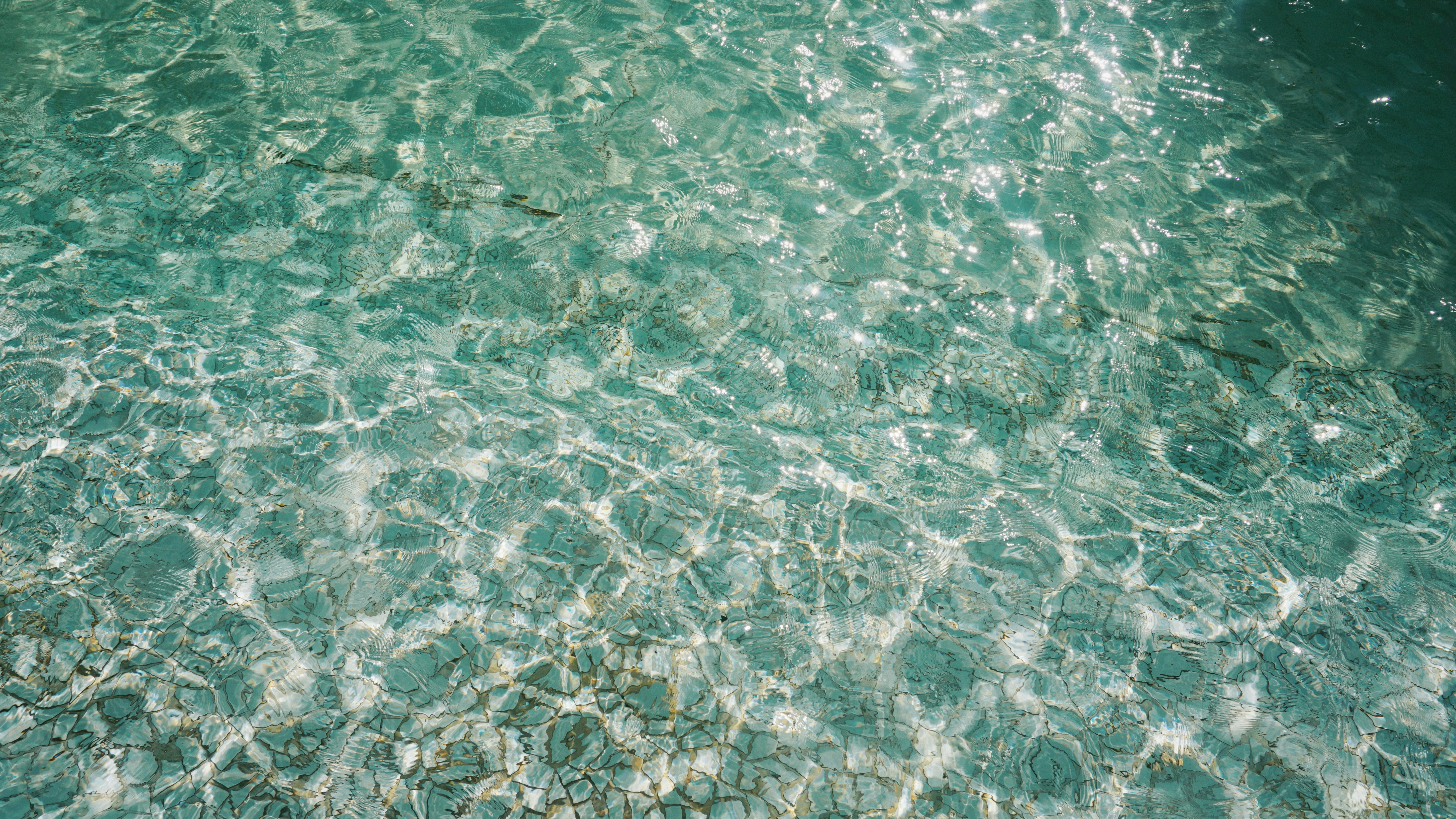 Shimmering Aegean Ripple: Sunlit Turquoise Sand Beneath Clear Shallows