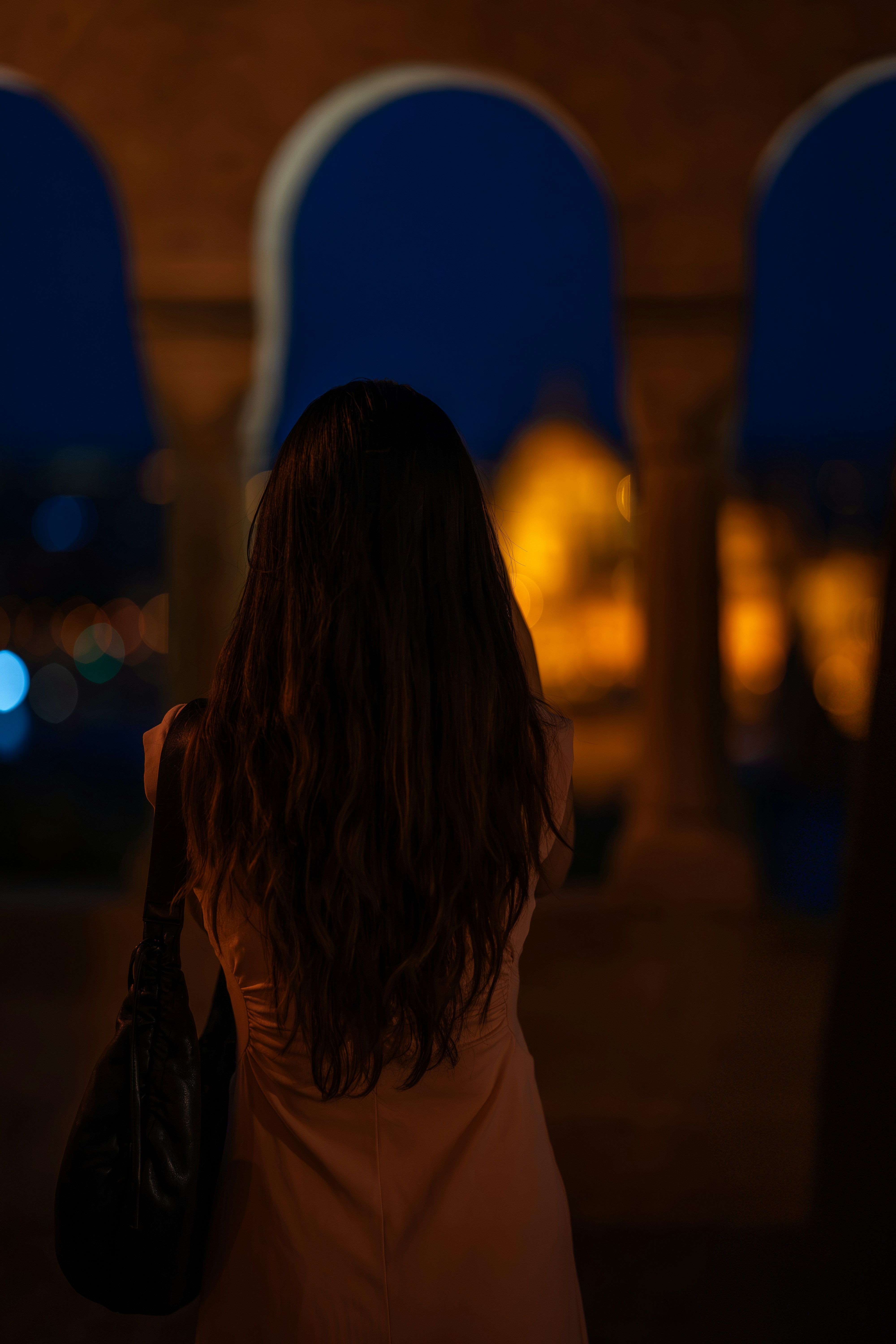 At the Night Archways: A Woman in Soft Light