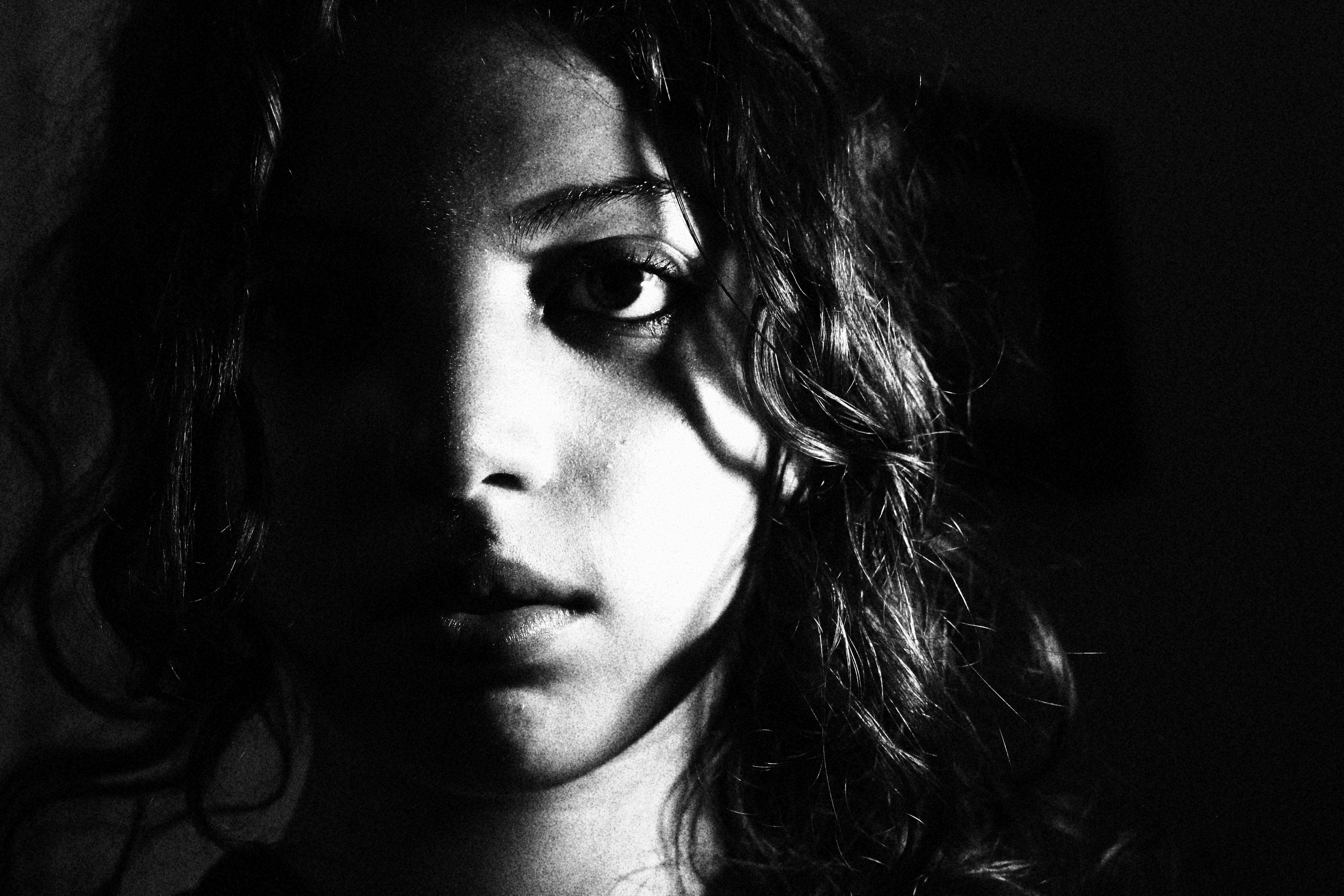Playing with shadows, a bare face of a woman.