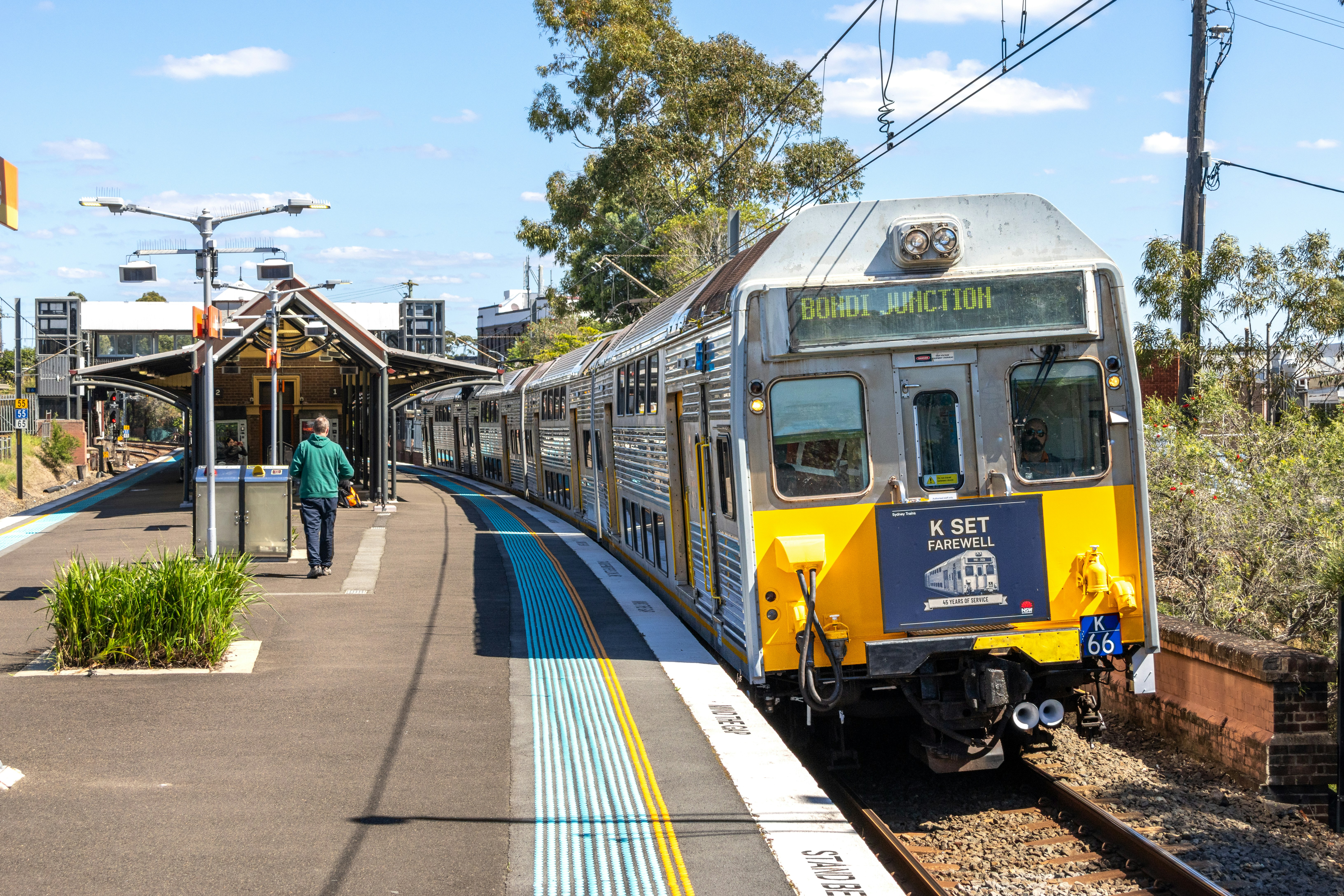 Platform Edge: Passengers, Tracks, and a Bright Blue-Fronted Train