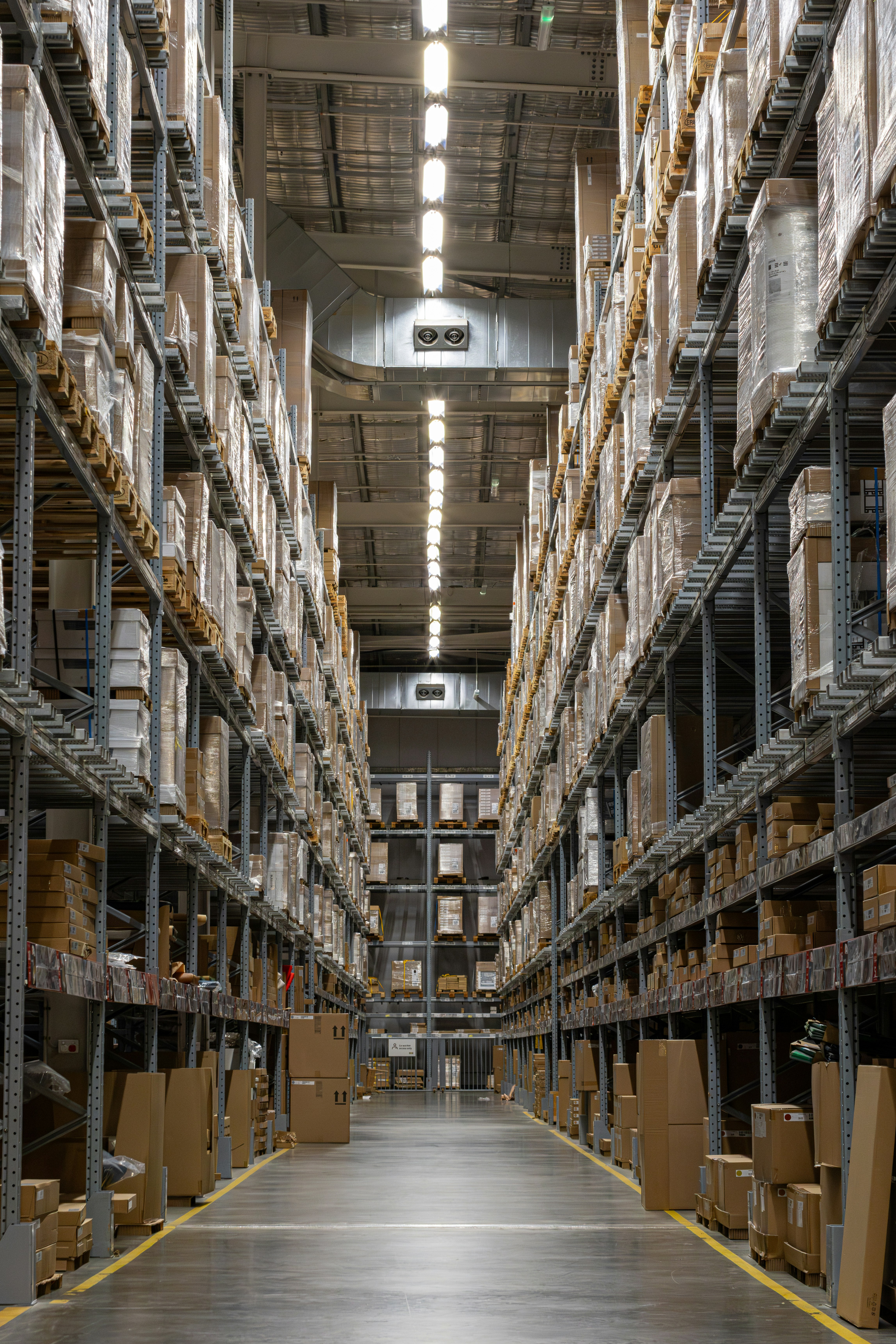 Aisle of Order: Endless Racks Under Industrial Light