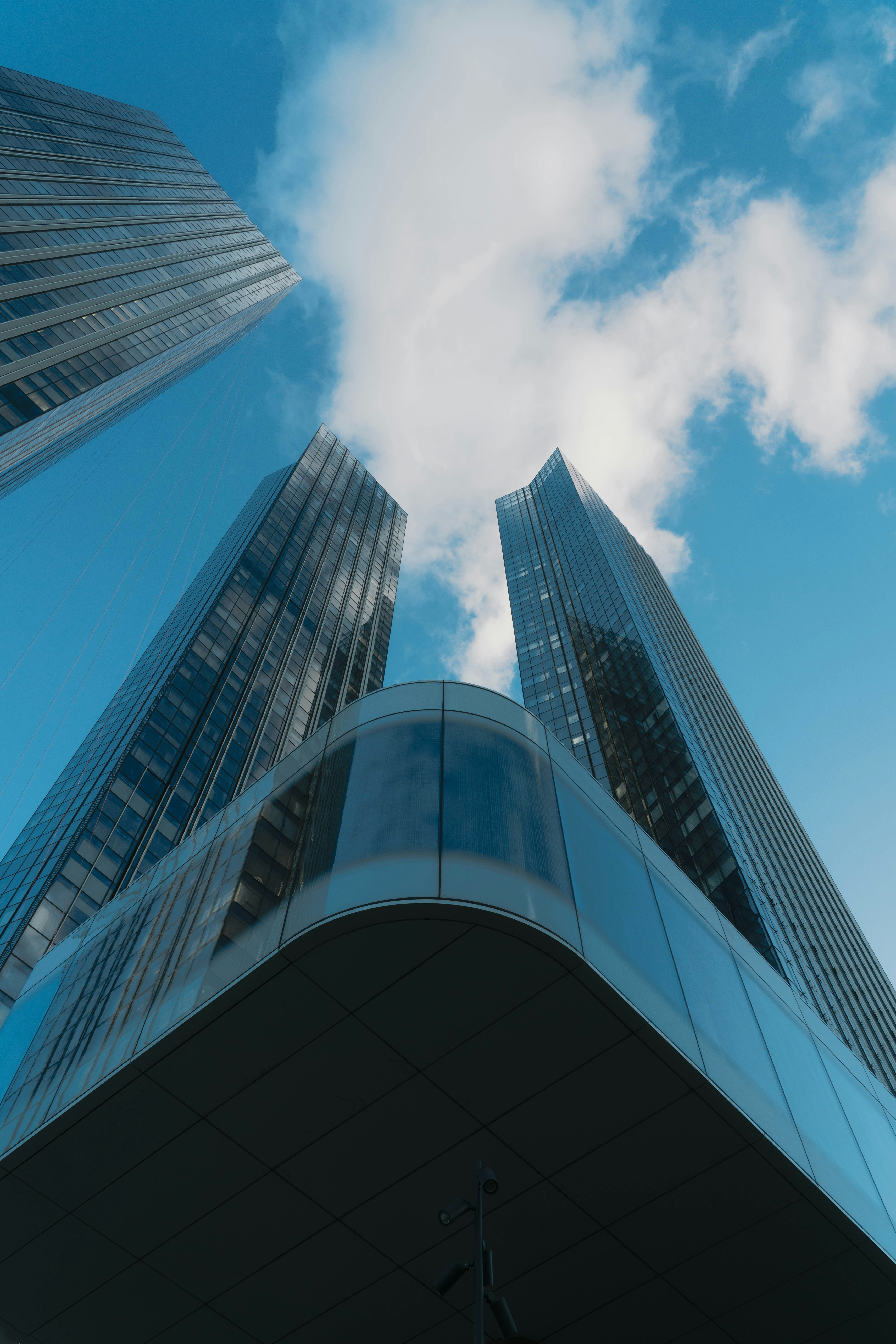 Ascendancy in Glass: A Vertical View of Modern Towers Against a Clear Sky