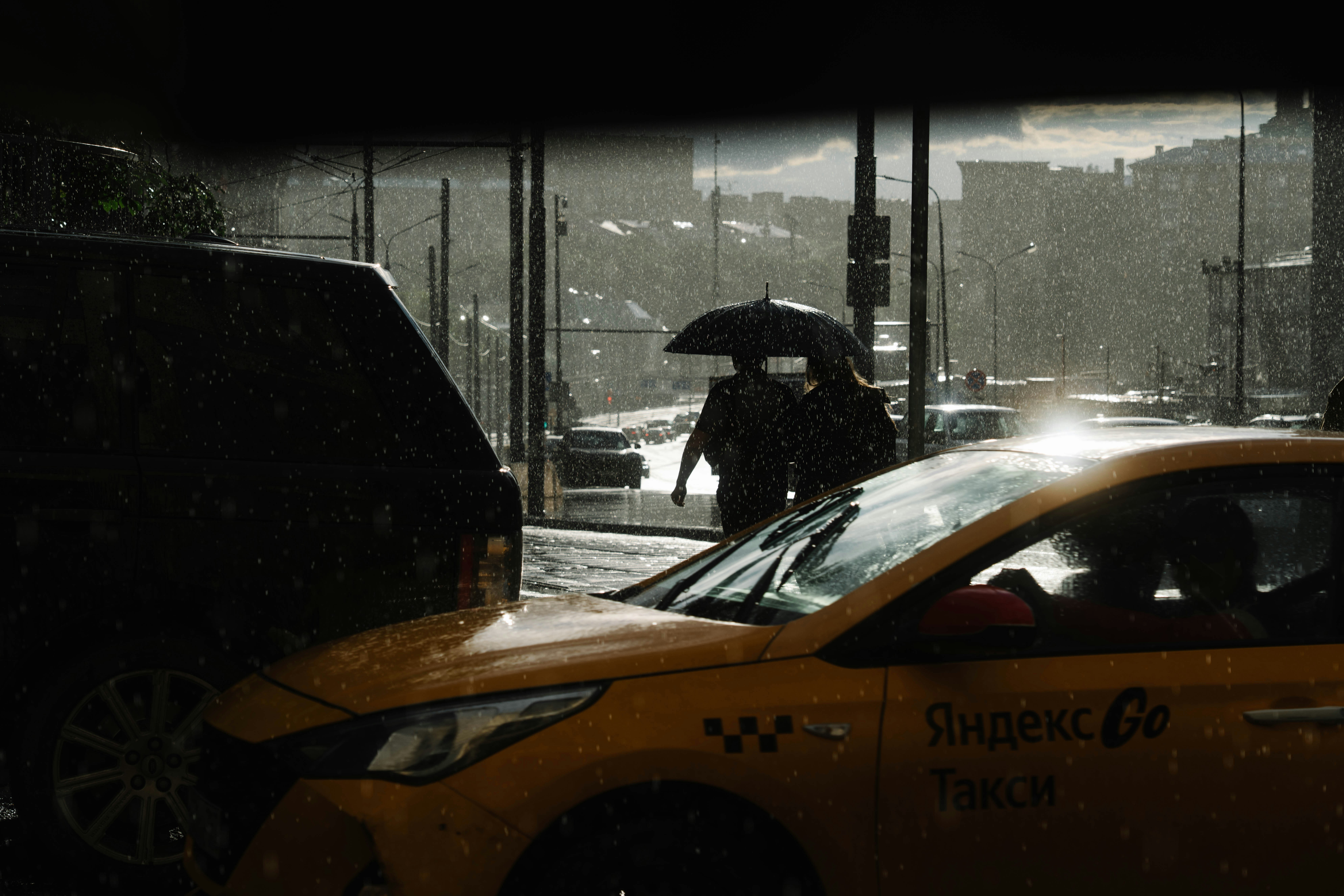 Umbrella in the Rain: A Taxi Scene at Dusk