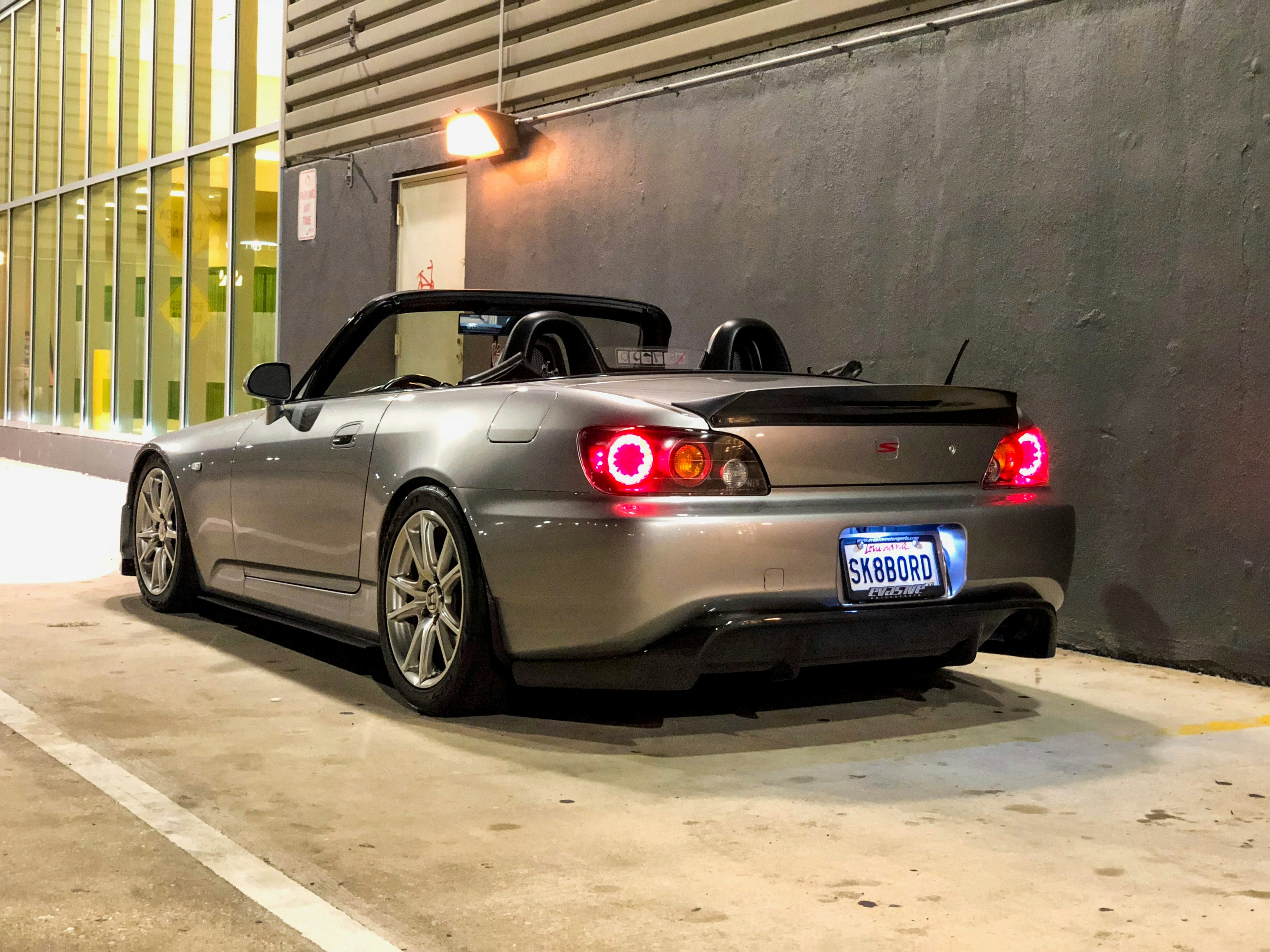 Silver Convertible at Night: Streetlight Glow and Trackside Mood