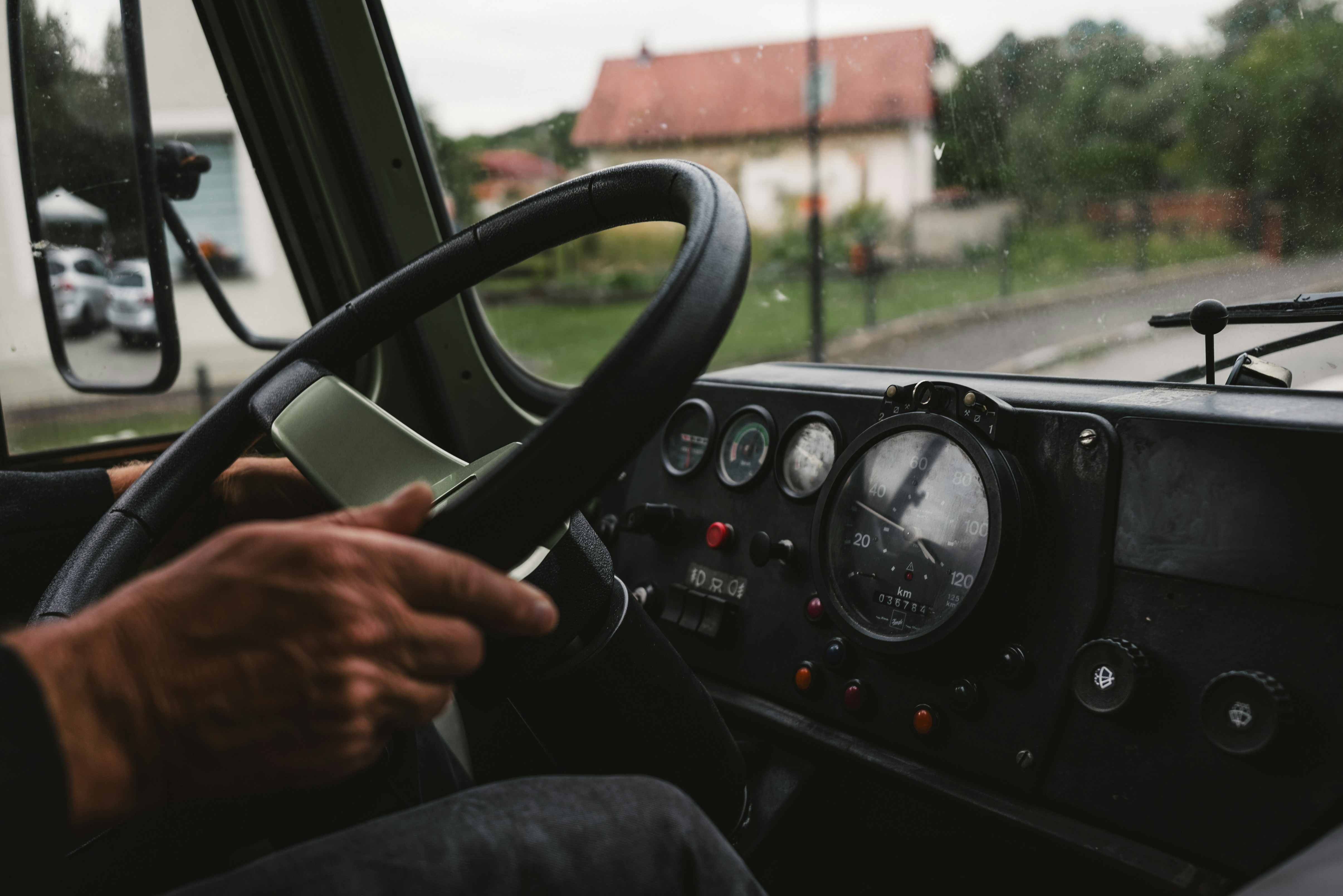 Driver's Hands on the Wheel: A Vintage Cab Interior in Focus