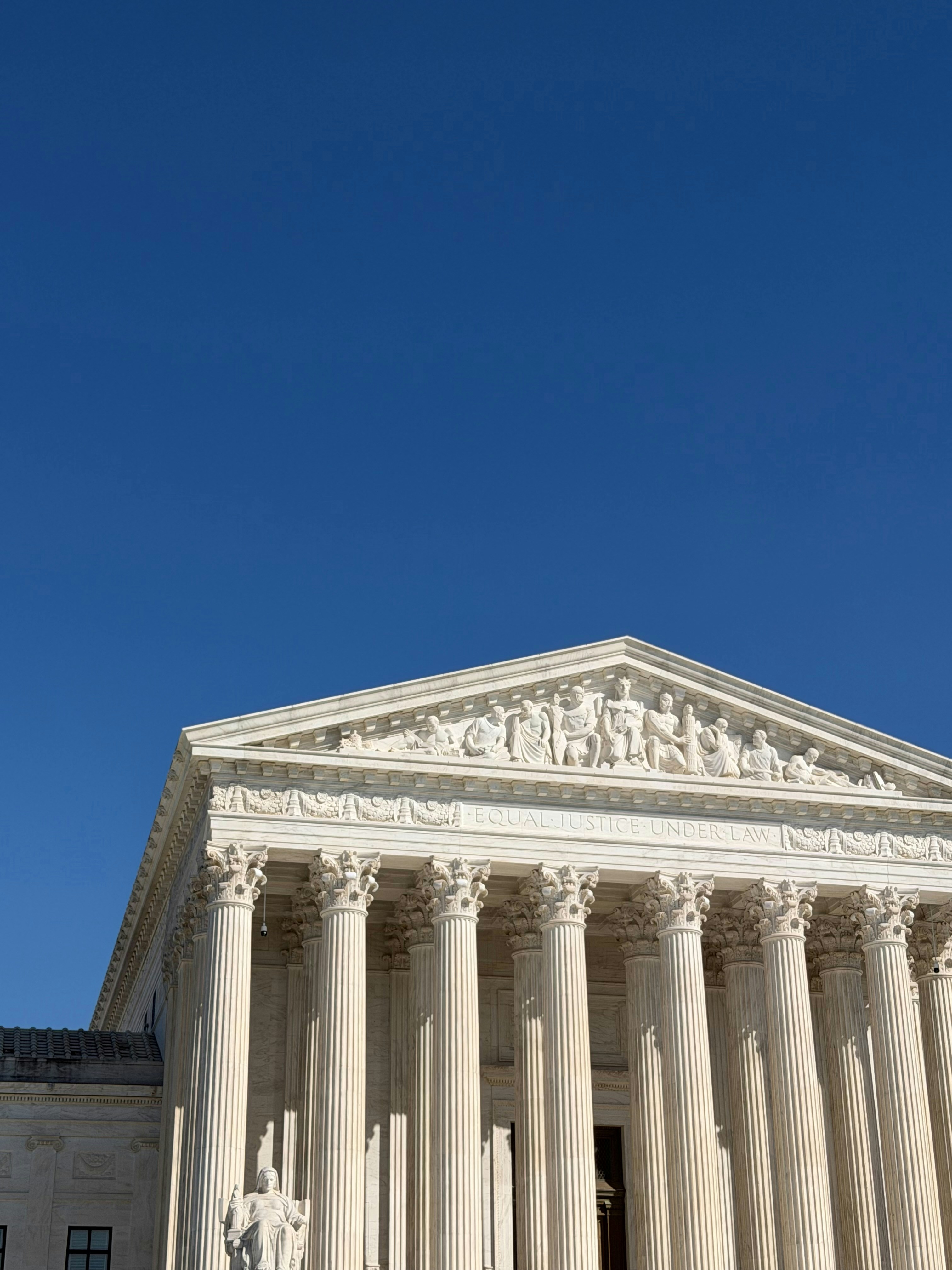 Colossal Marble Facade: Classical Justice Under a Clear Sky