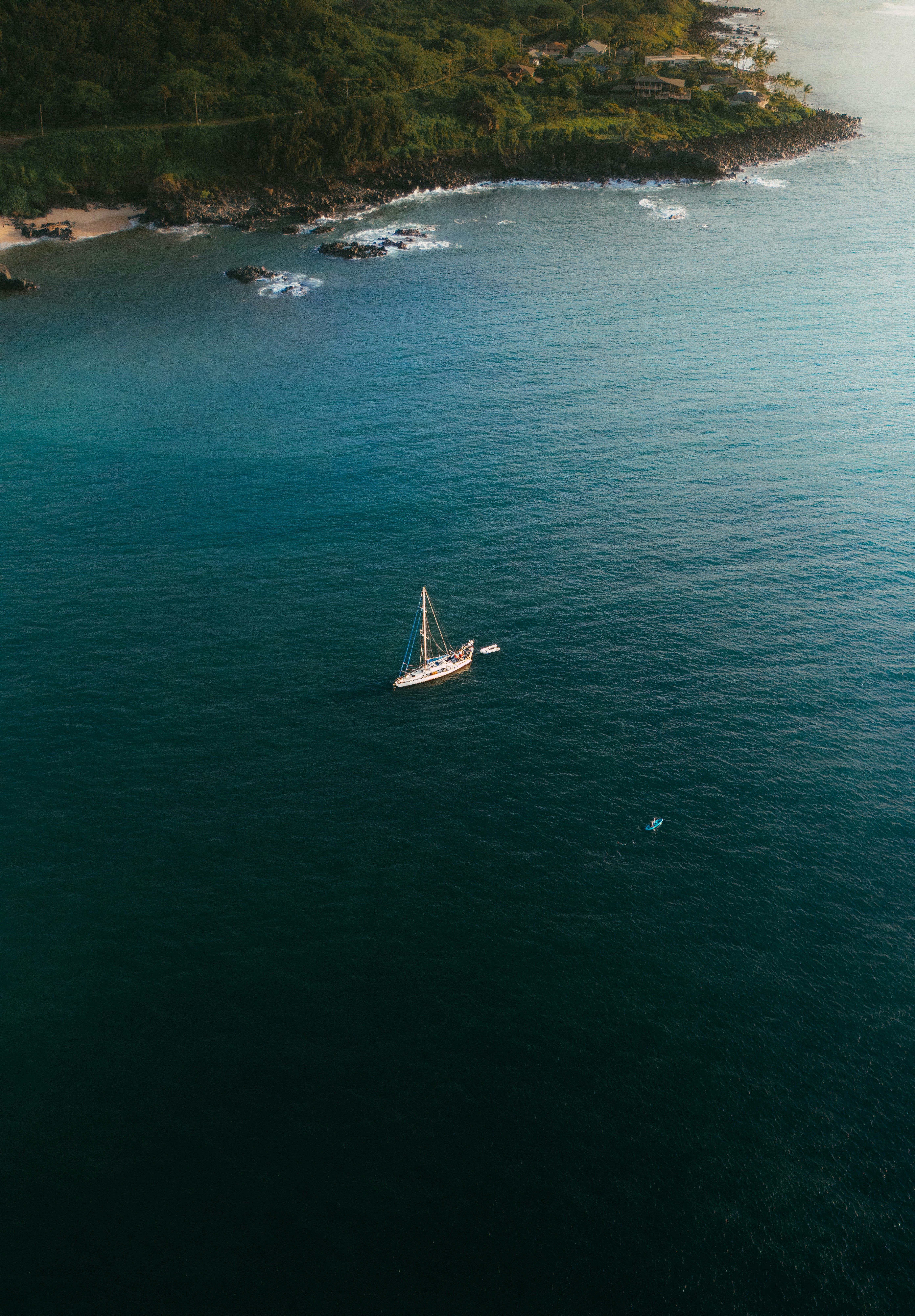 Sailboat Adrift: A Lone Vessel in Velvet Blue Waters