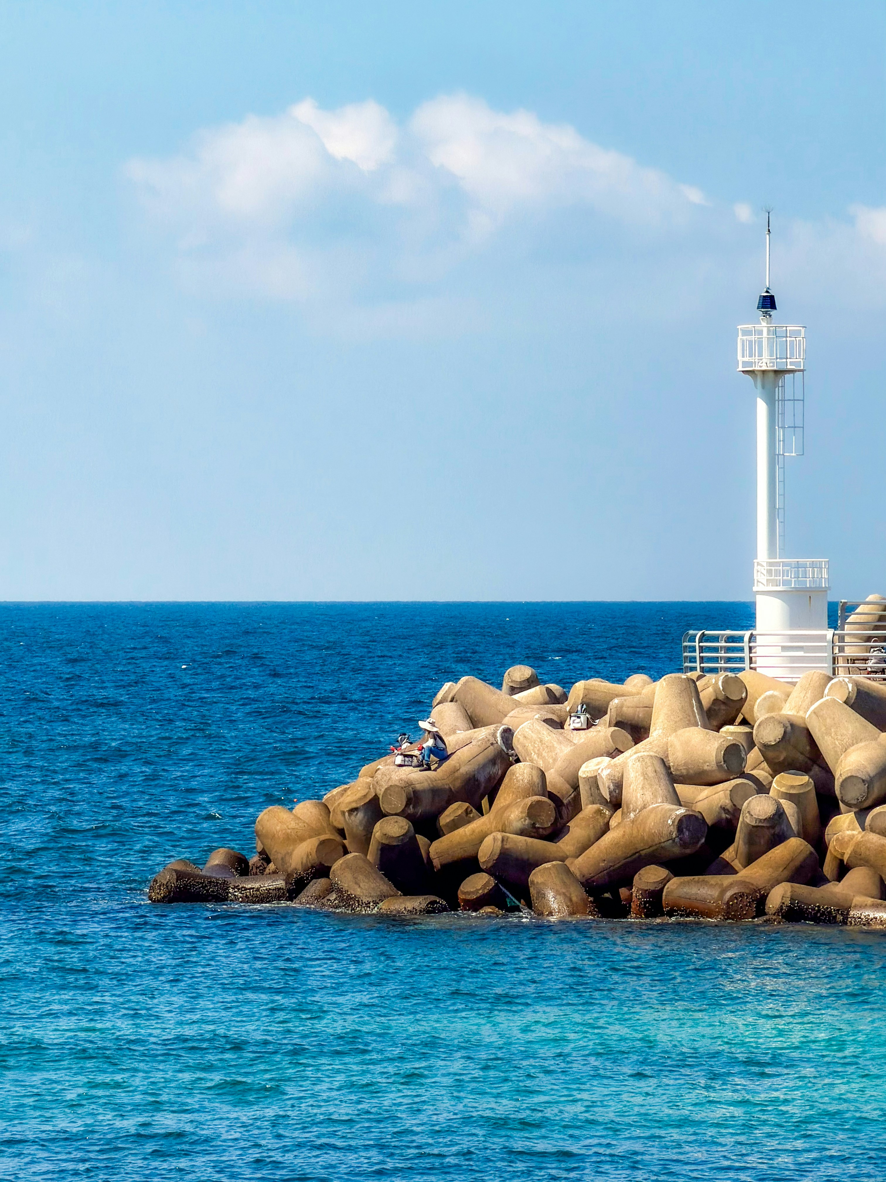 Lighthouse Sentinel Over Calm Blue Seas