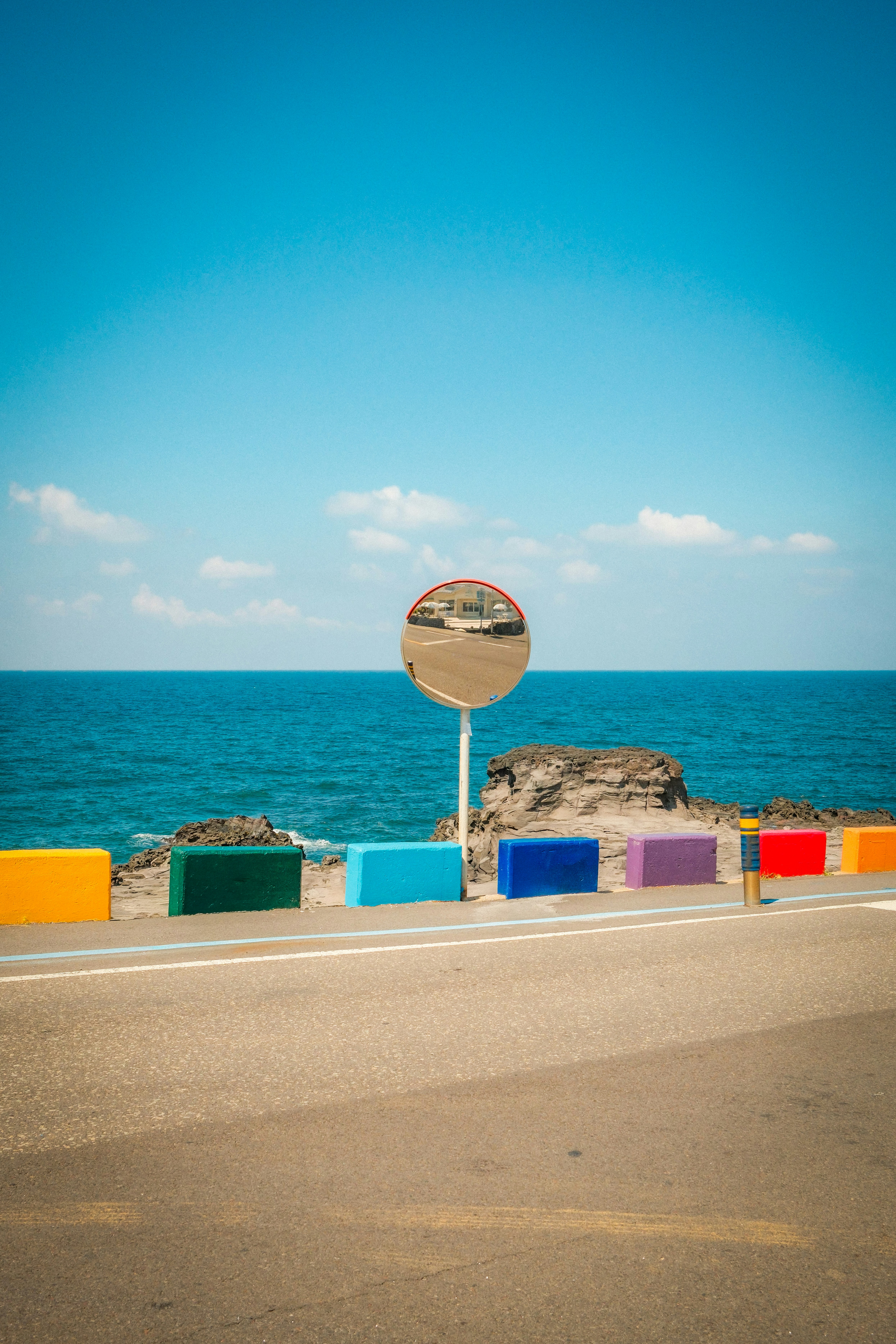 Sea Road Reflections: A Colorful Coastal Barrier by the Sea