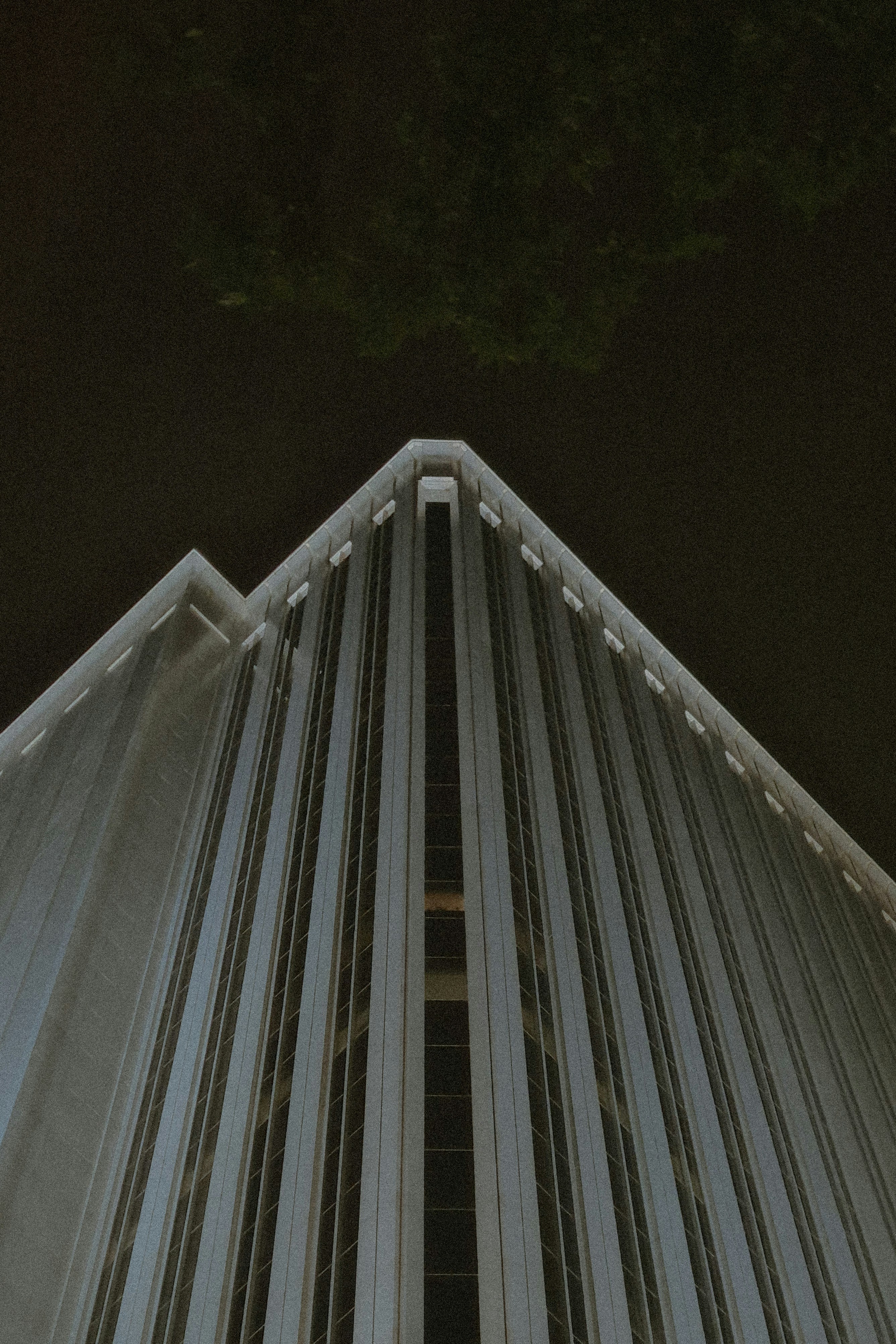Architectural Apex: Nightfall at the Tilted Tower Facade