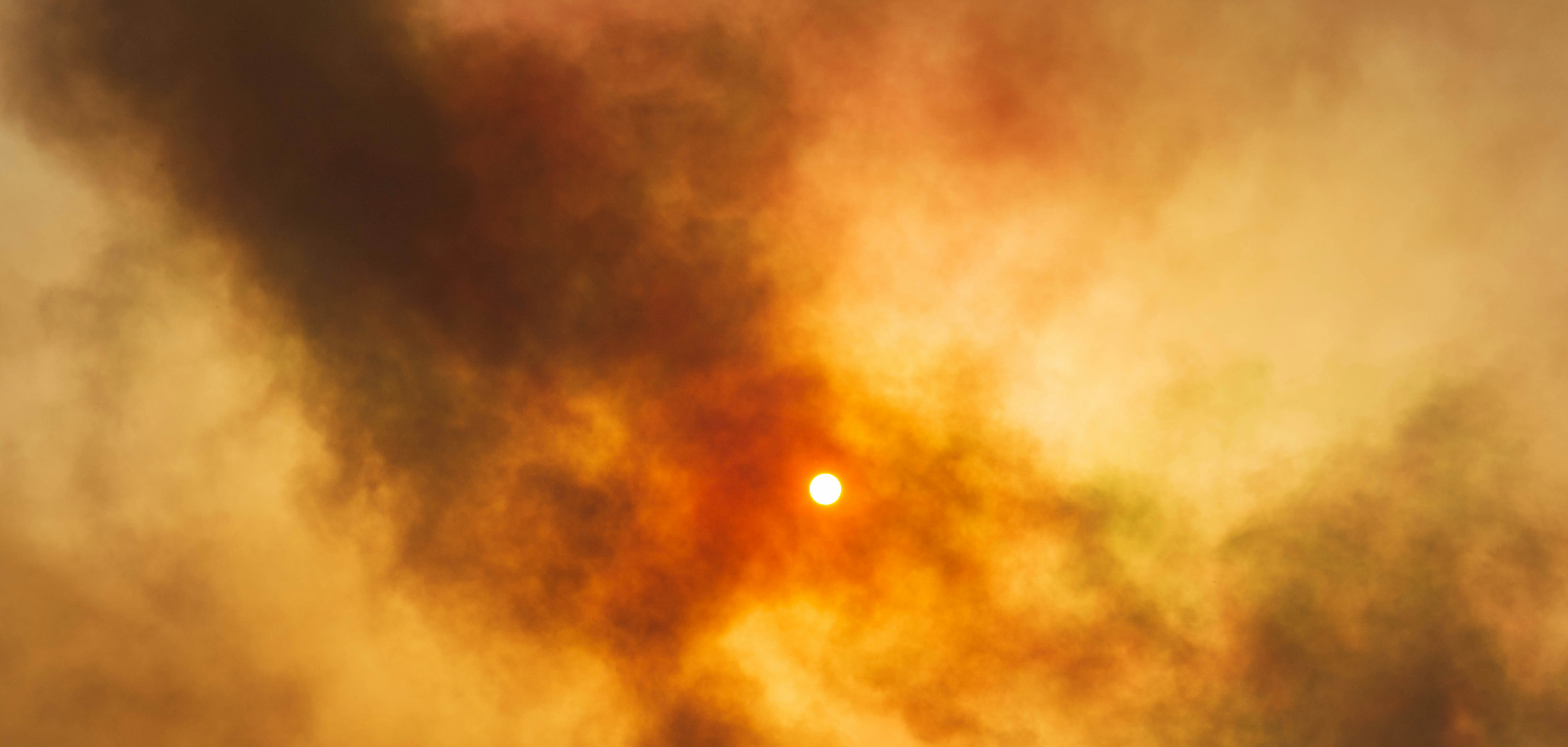 Ember Globe: Sunburnt Clouds Behind a Fiery Veil