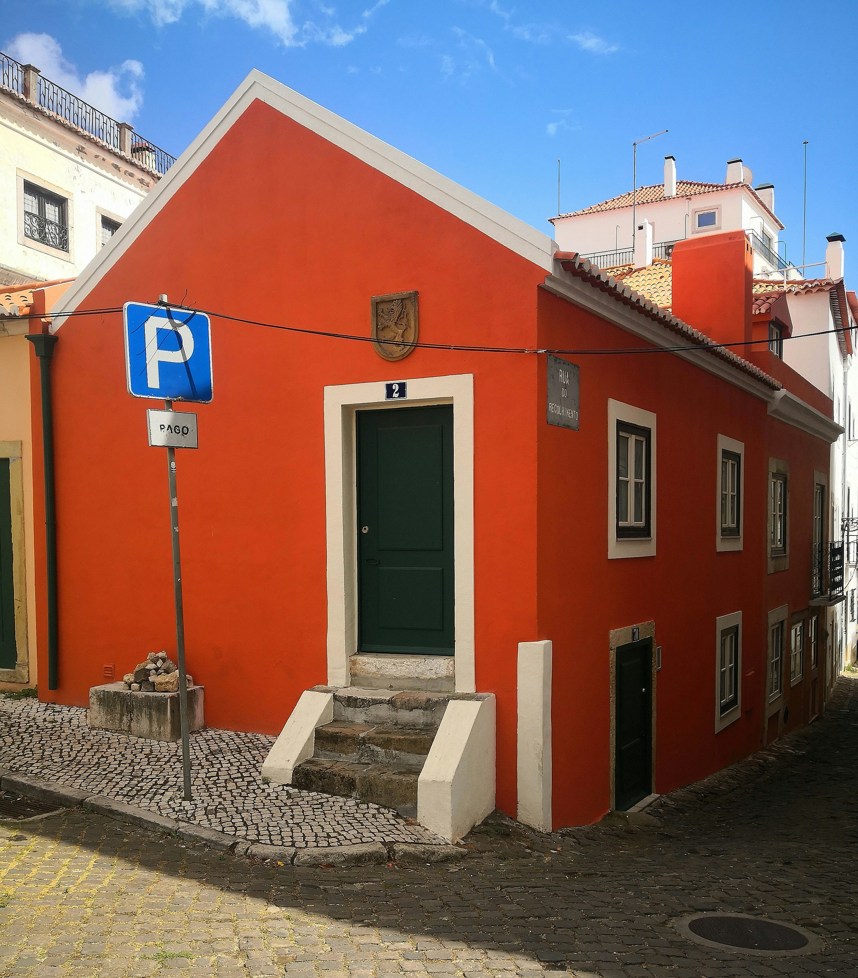 Sunlit Orange Corner: A Portuguese House Basks by Cobblestone Lane