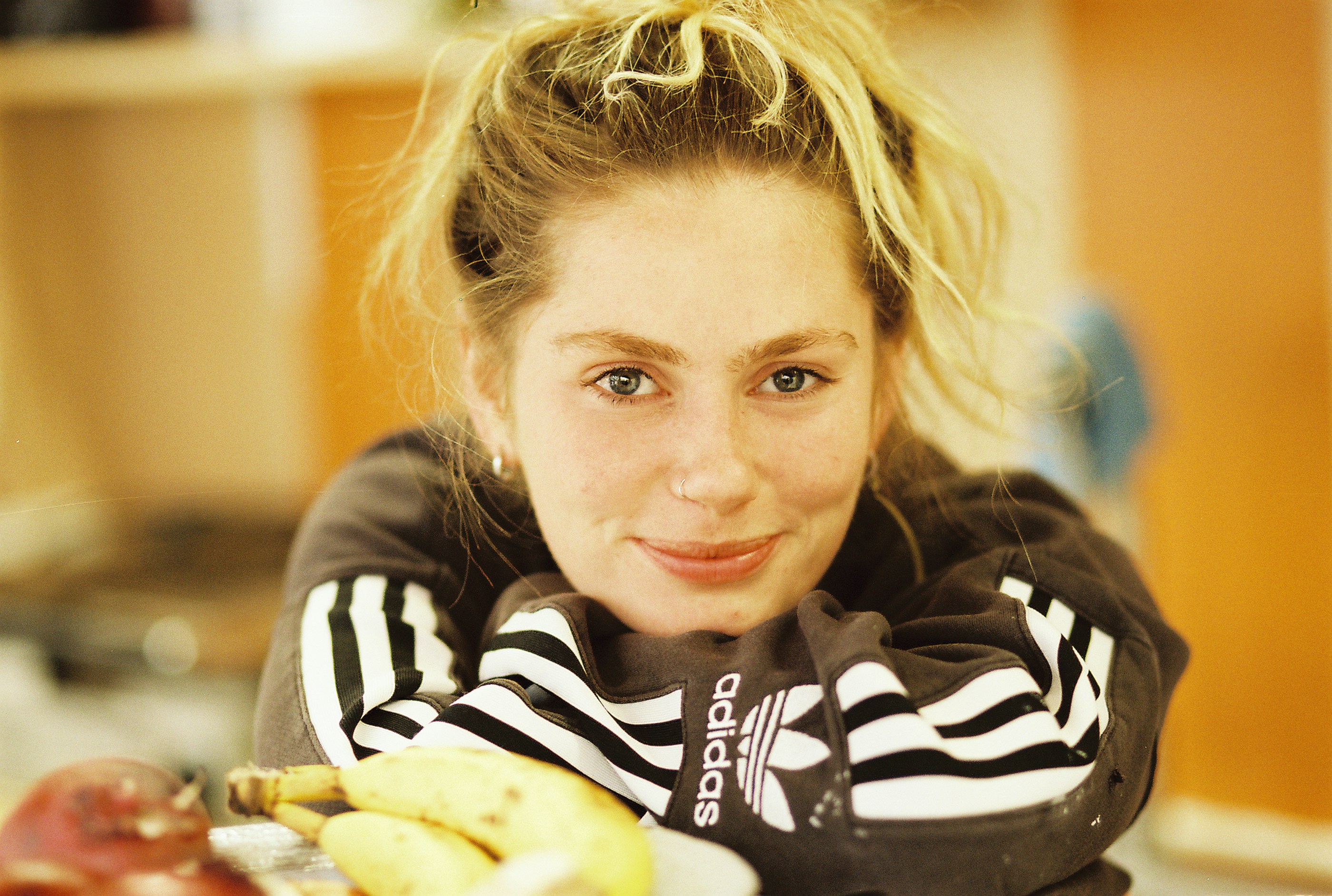 Soft-focus Portrait of a Cheerful Student Resting her Chin on Folded Arms