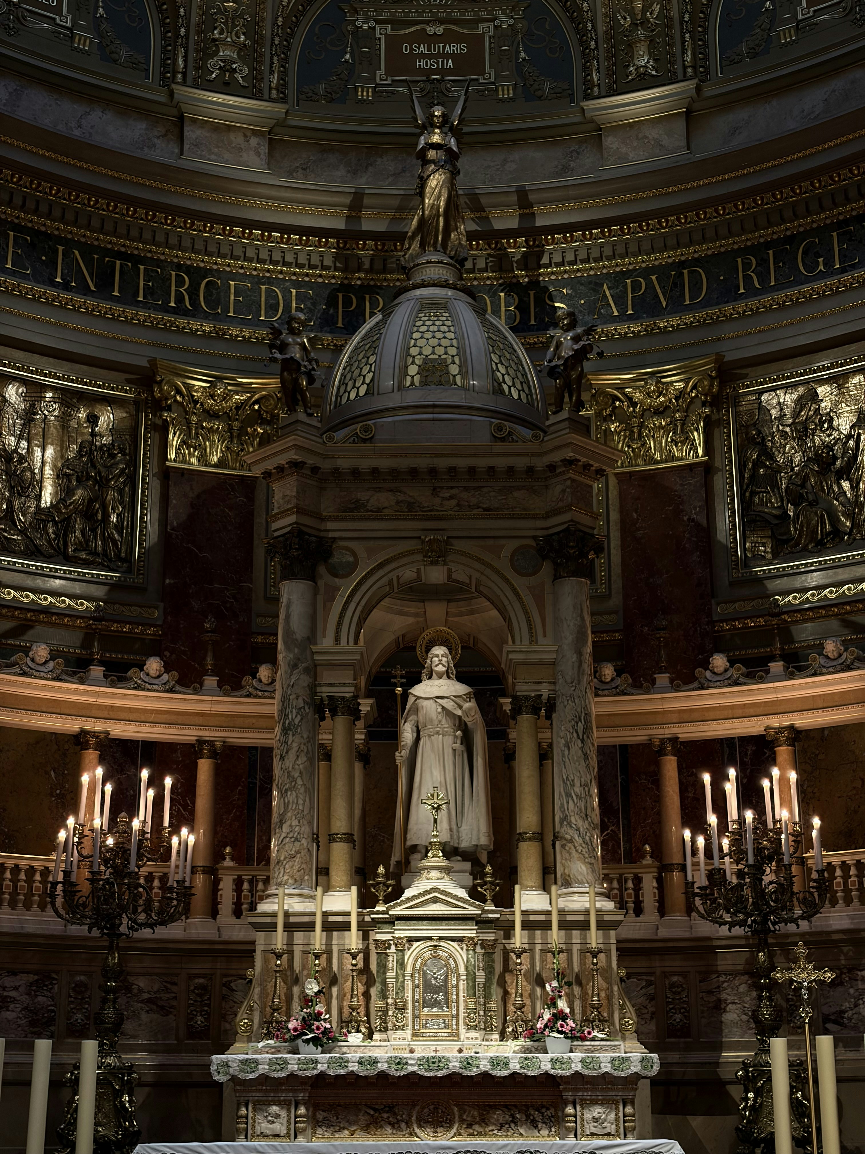 Sacred Altar in Dim Light: Statues, Candles, and Marble Columns