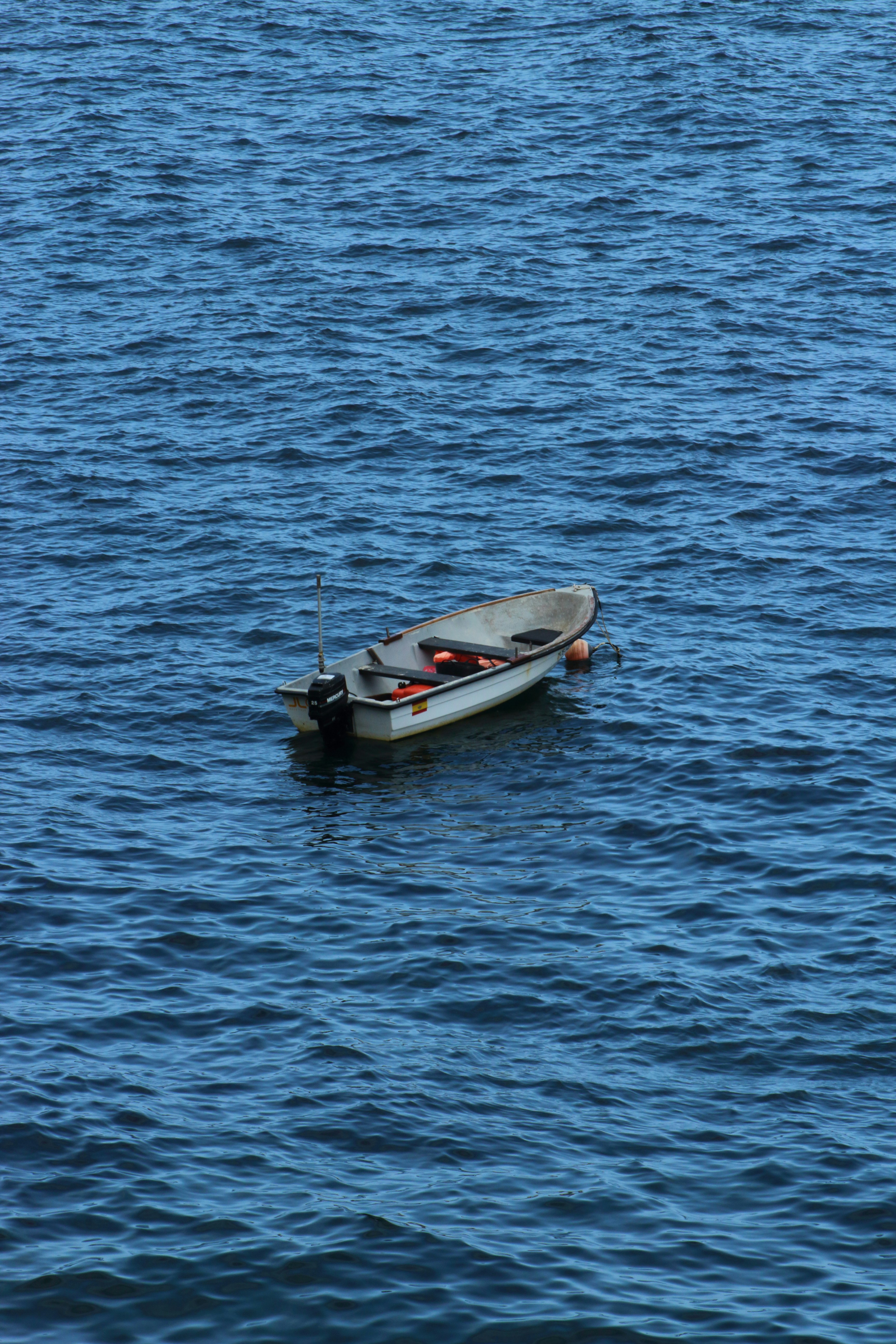 Single Boat Drifting in Blue Quiet Sea