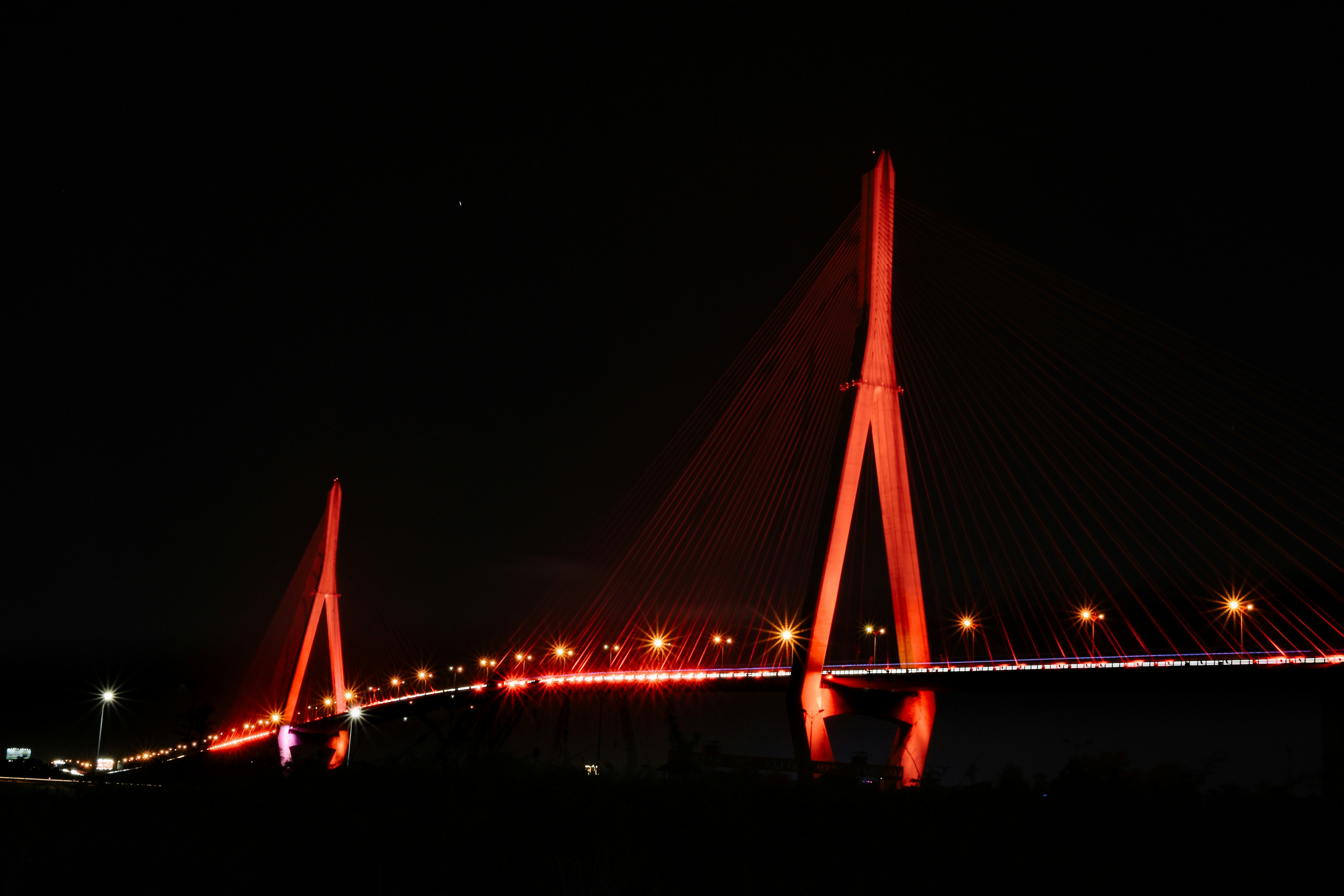 Crimson Span: Night Lights Cascading Across a Modern Bridge