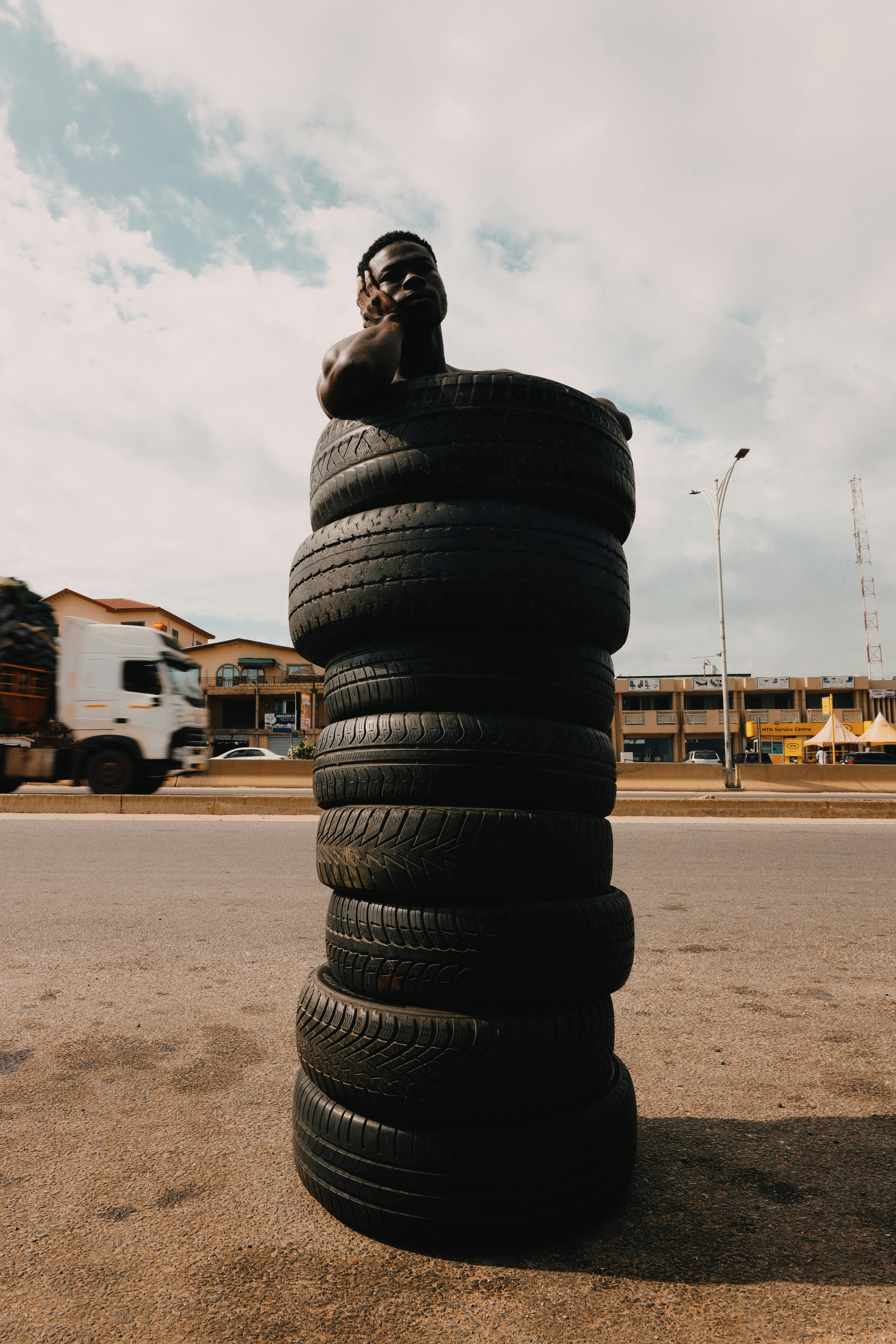 Tire Stack Silhouette: A Quiet Gaze Above the Street