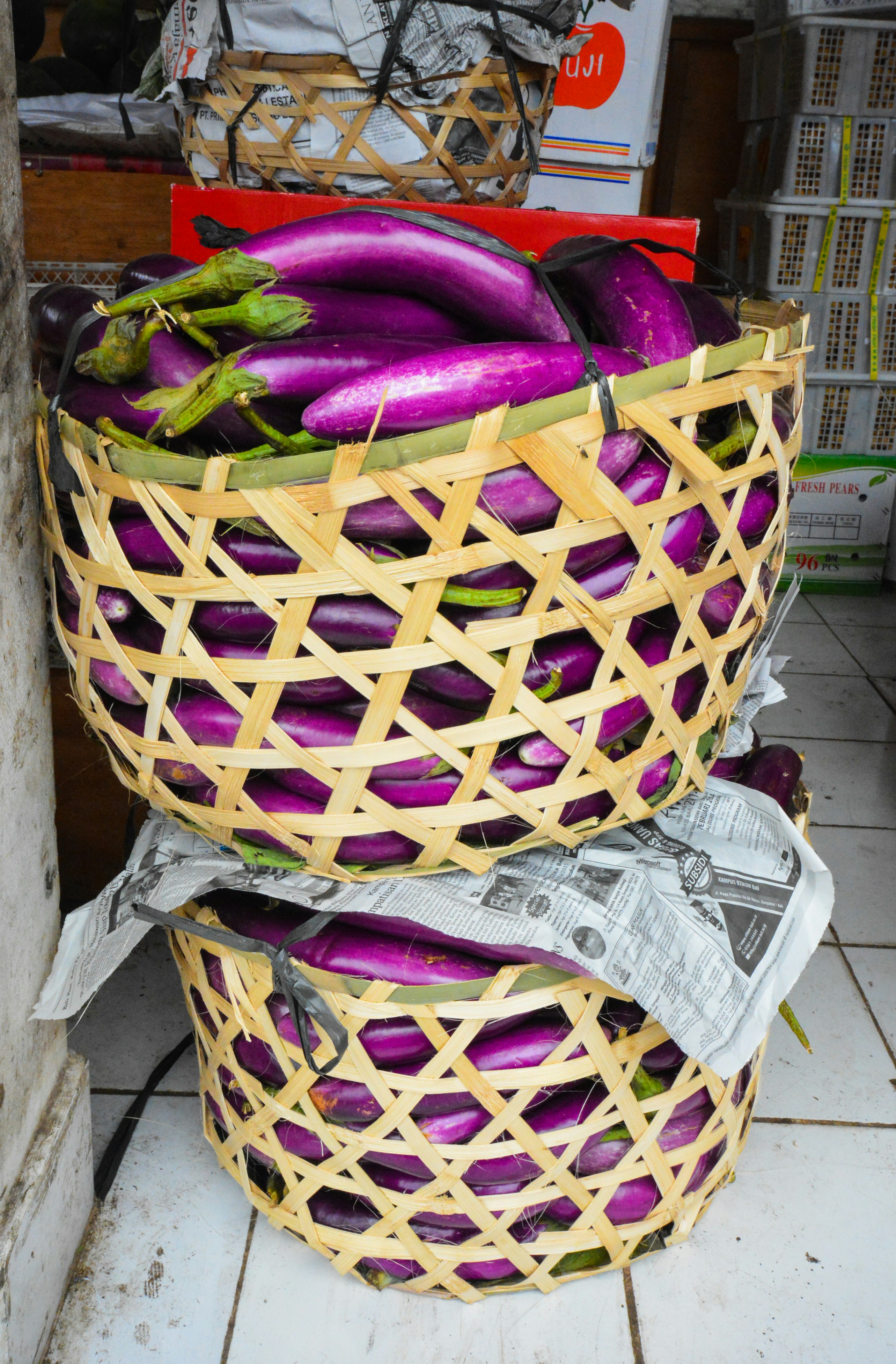 Purple Harvest: Stacks of Eggplants in Woven Baskets