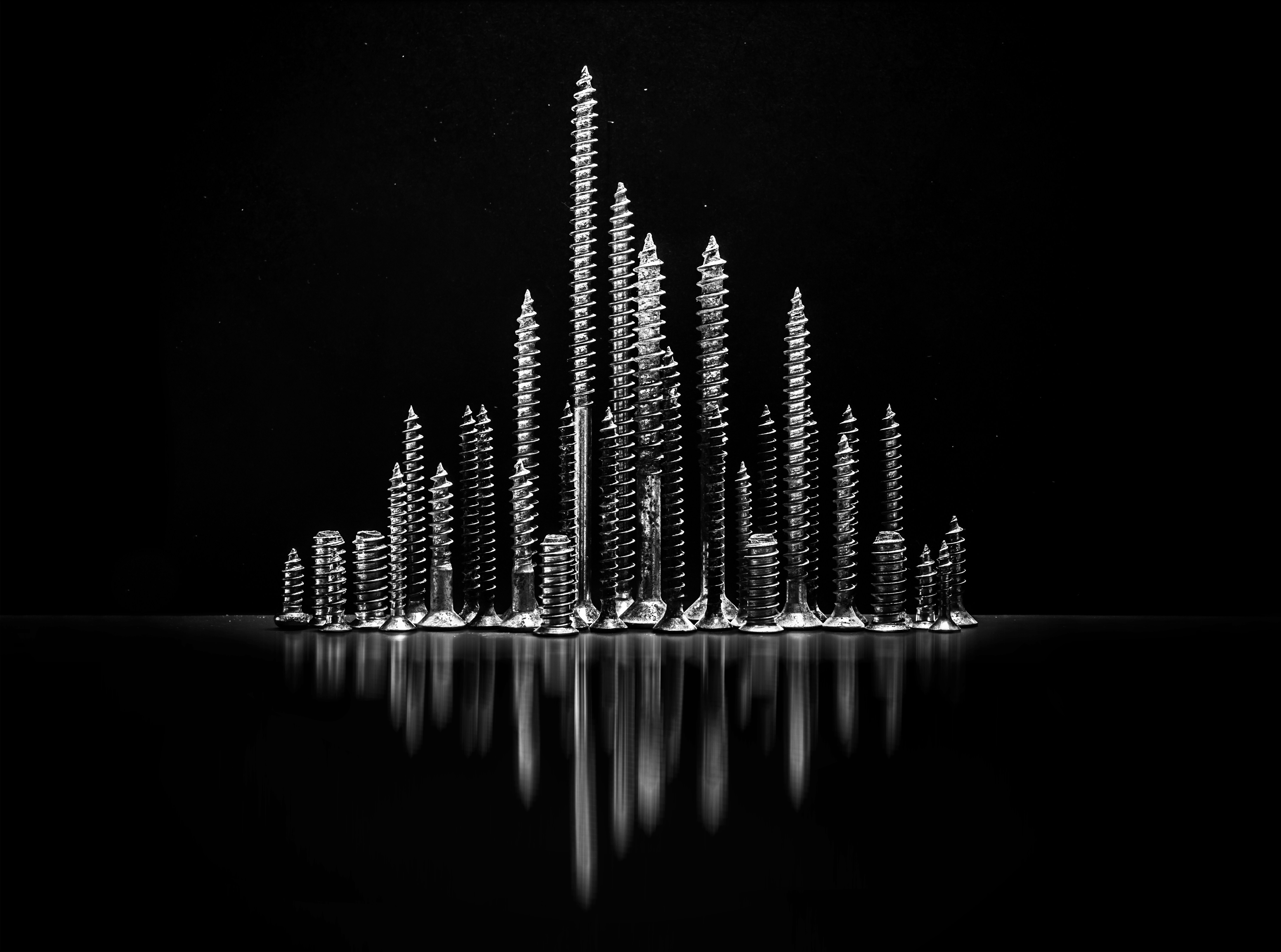 Ferrous Skyline: a night-time assembly of screws rising from a dark sea