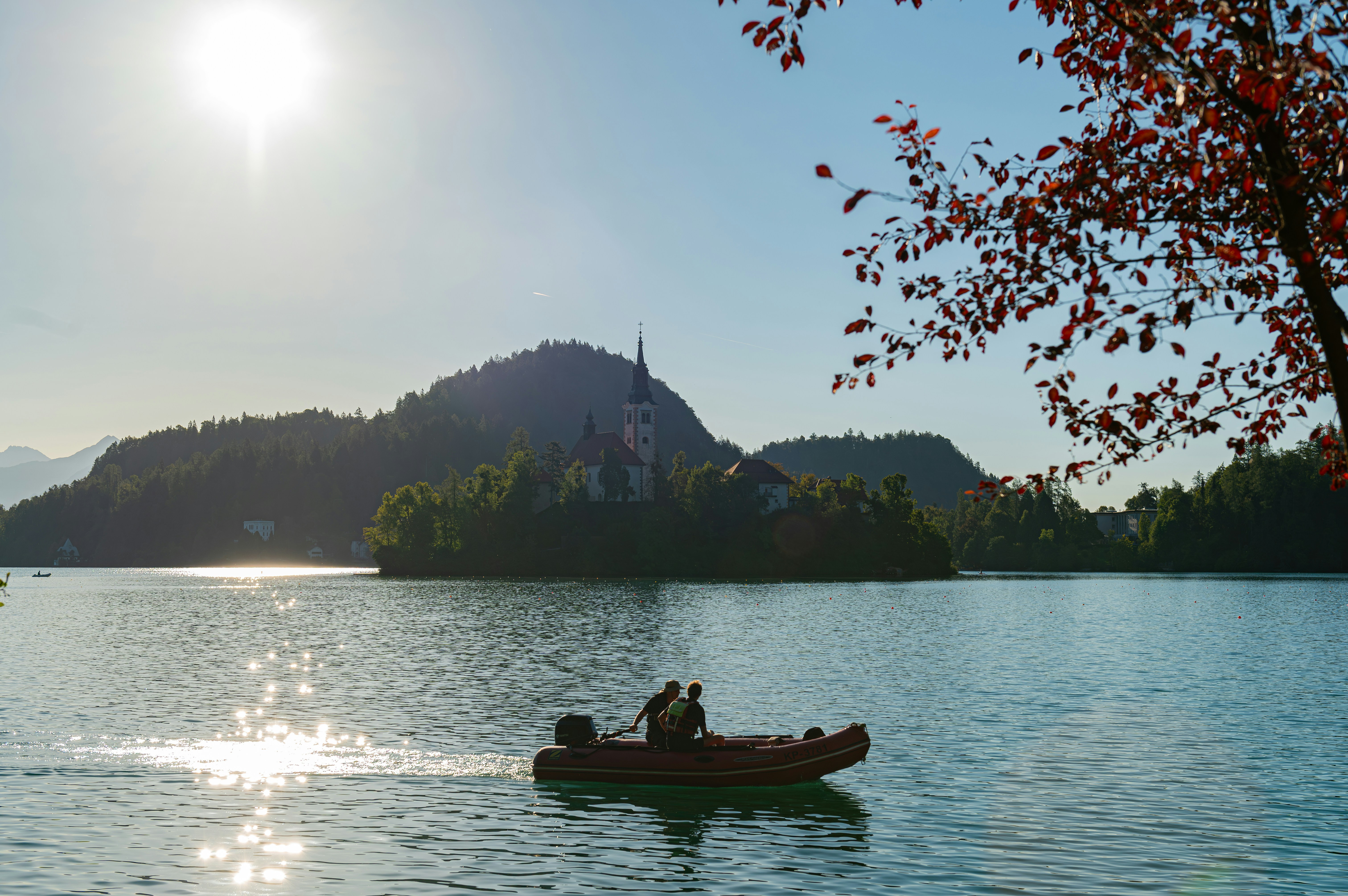 Majestic Lake Portrait: A Small Boat Cleaving the Sparkling Surface
