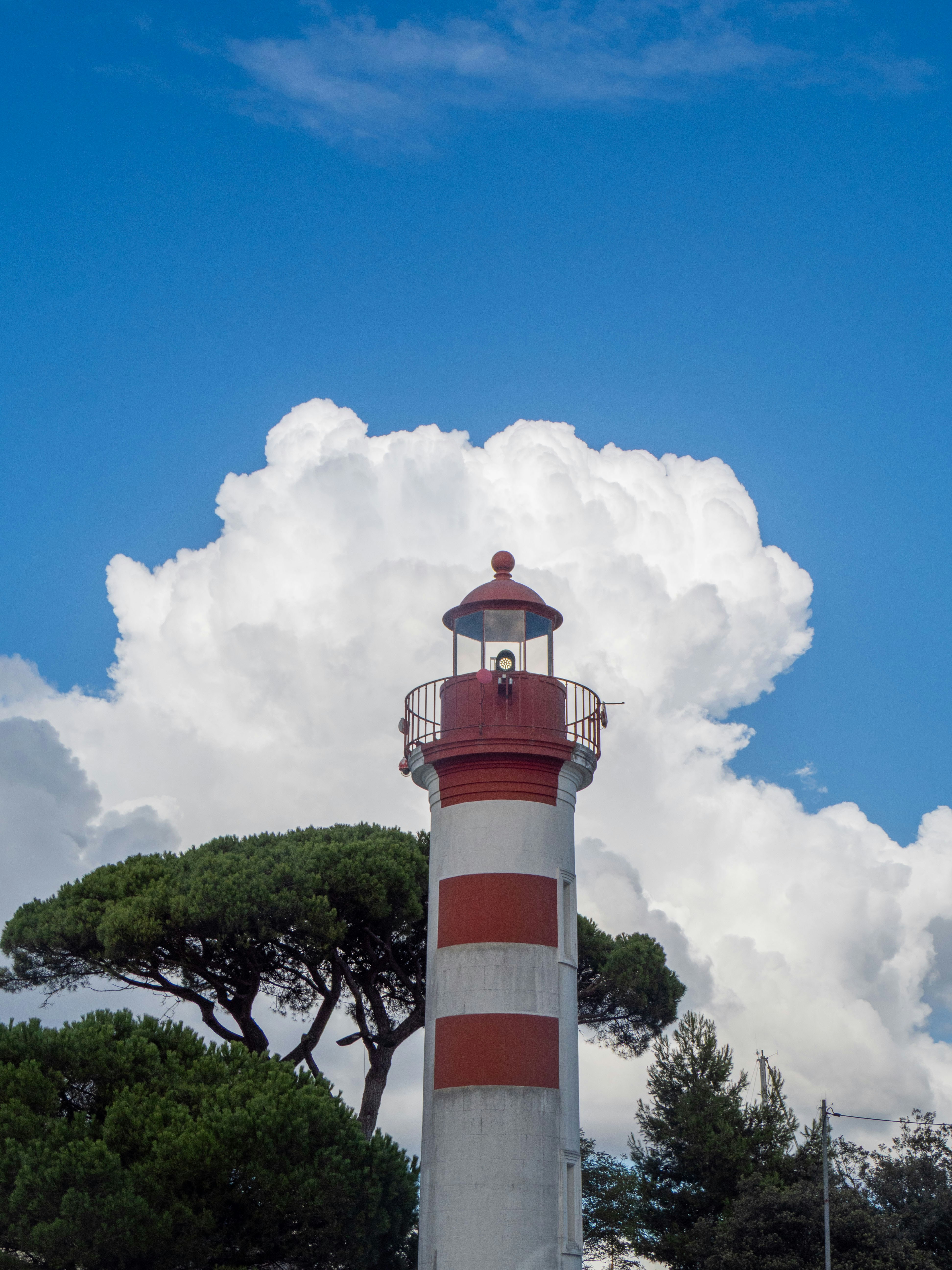 Red and White Beacon Under A Plump Cloud