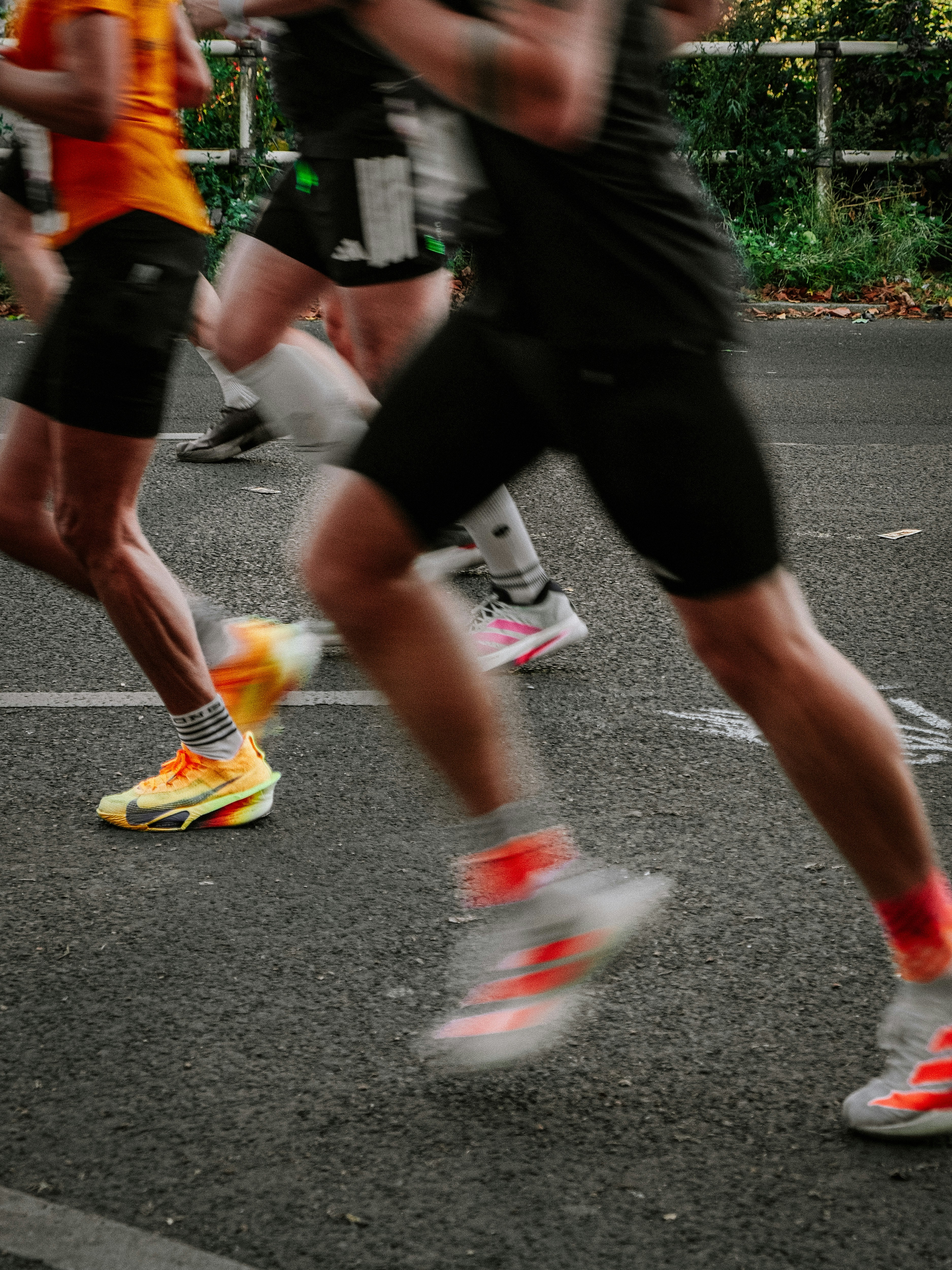 Runners in Motion: Blurred Stride Across the Asphalt