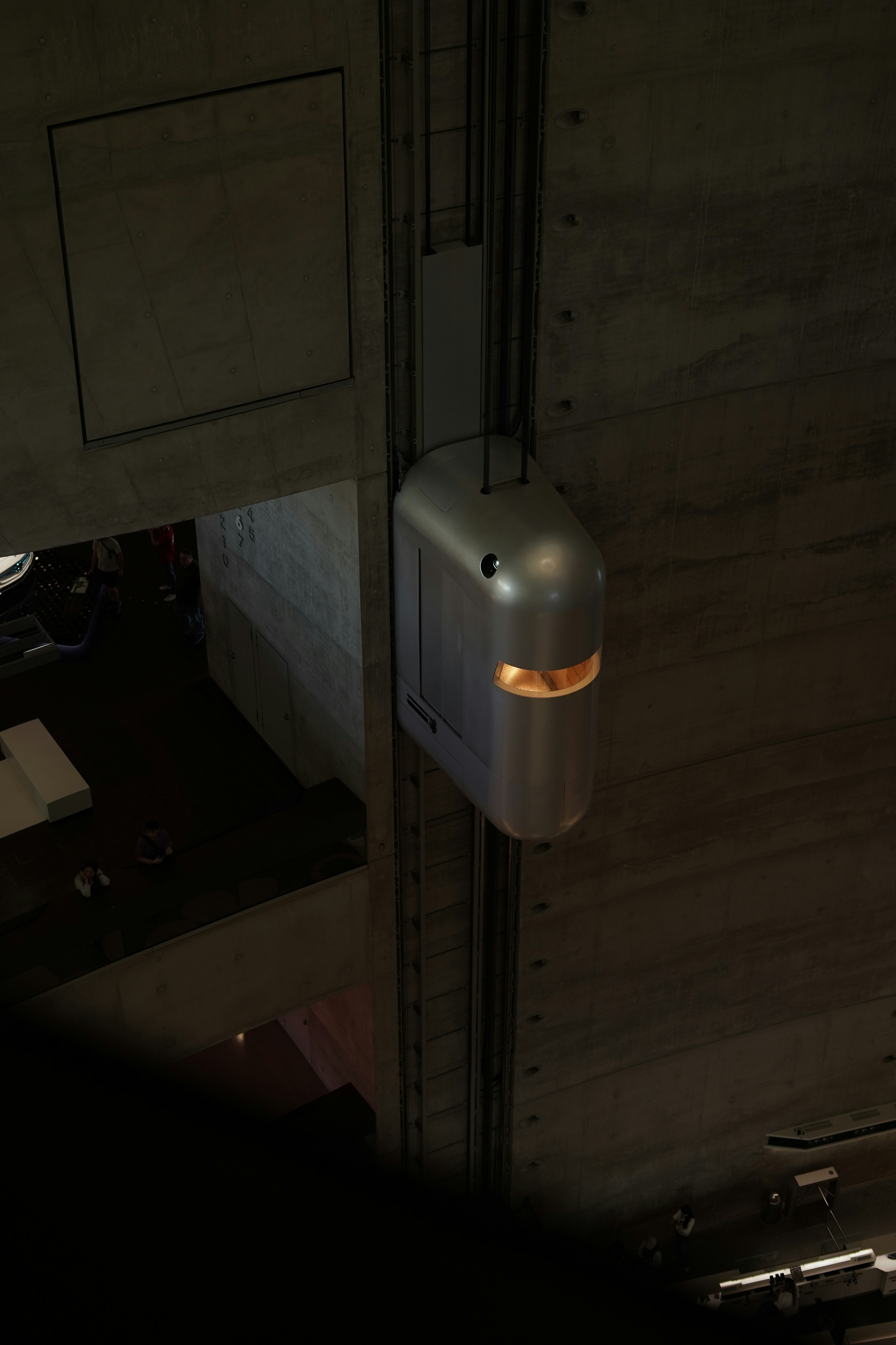 Elevated Capsule: A Modern Lift Suspended in Concrete Silence