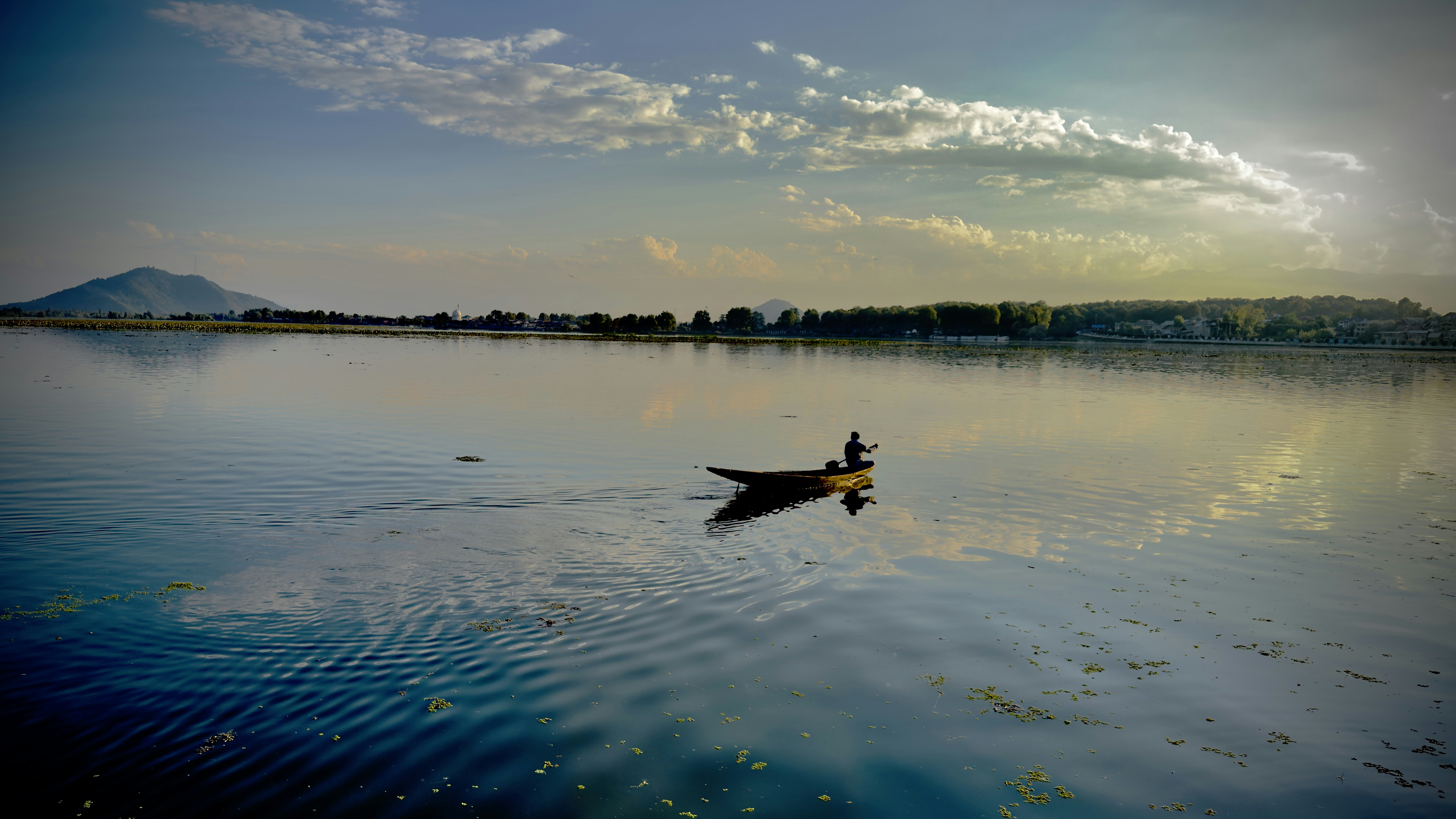 Solitary Rowboat Against a Glassy Horizon