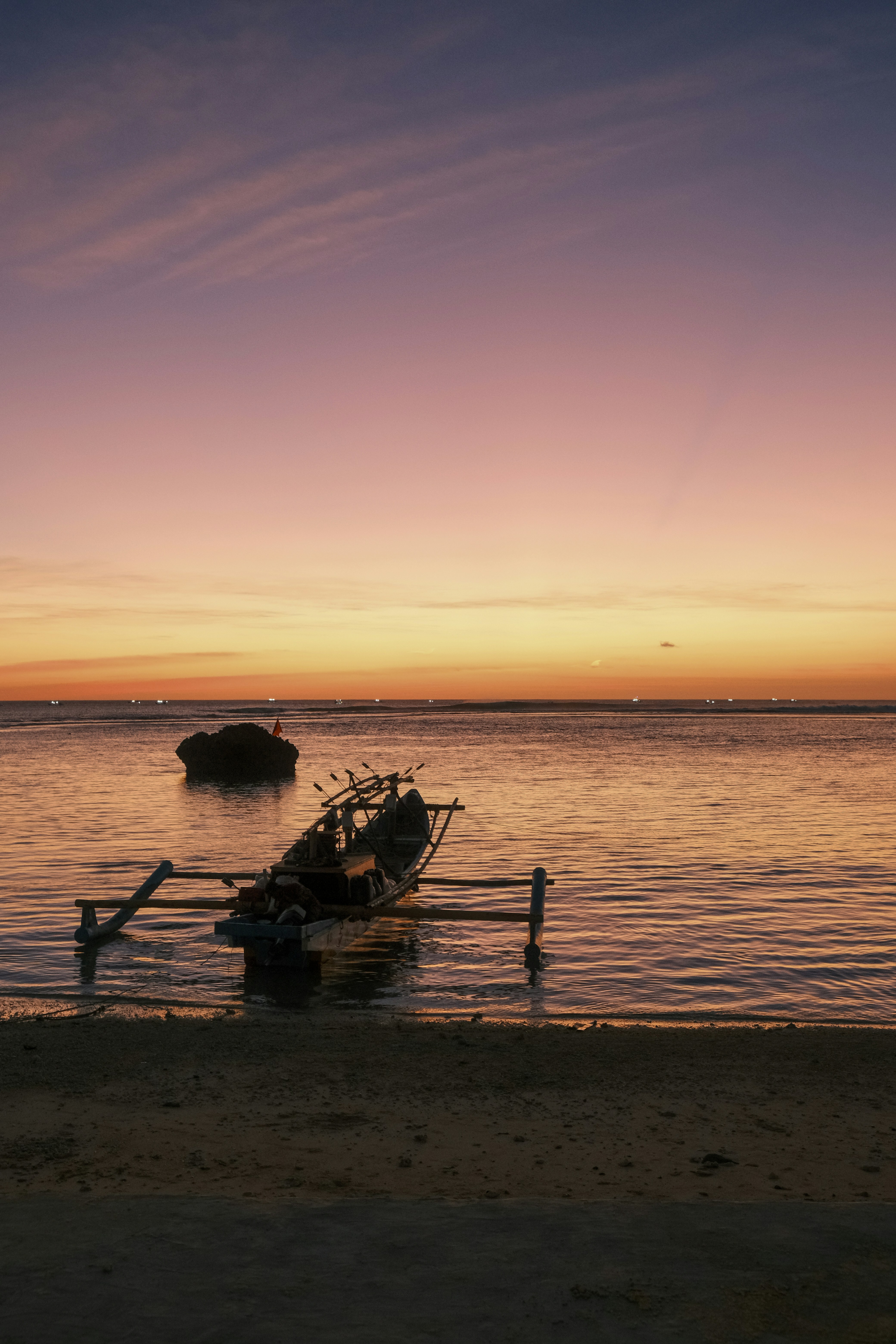 Silhouette Boat at Dusk: A Tranquil Shoreline Beneath Alpenglow Sky
