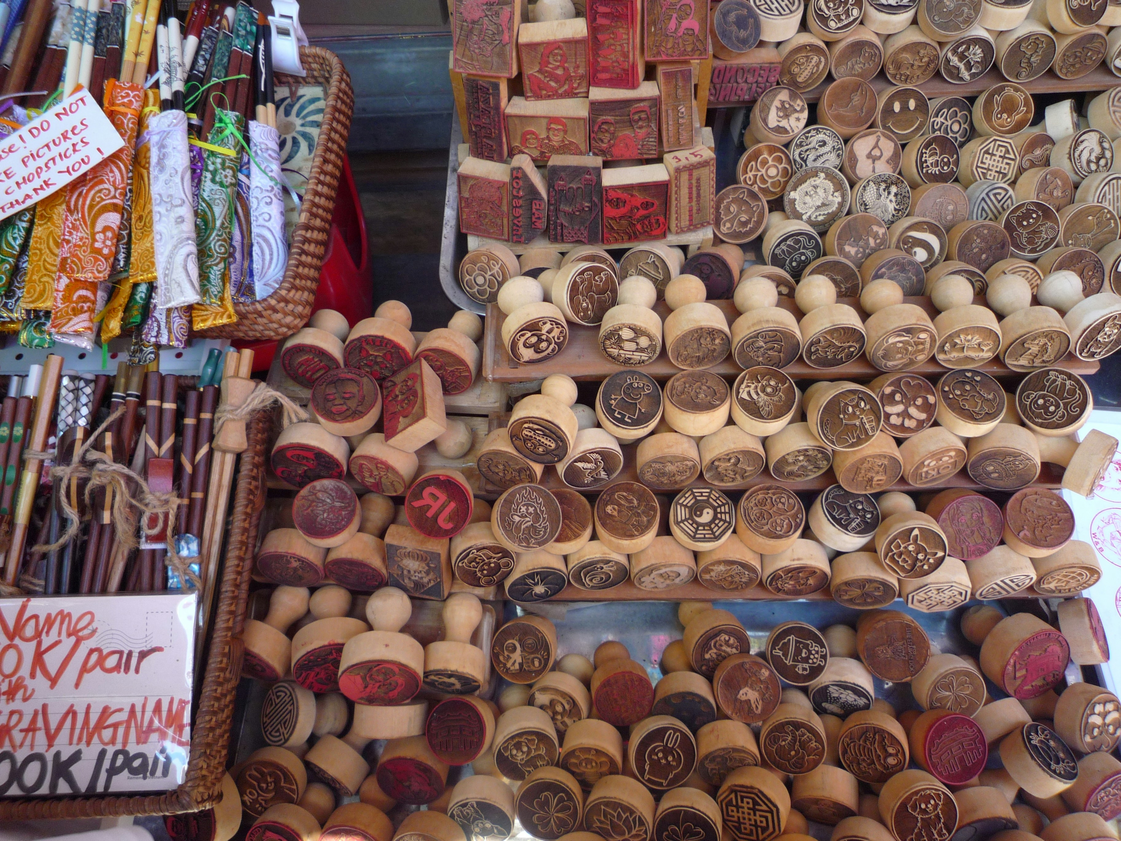 Carved tokens and stamps cascade in a colorful market display