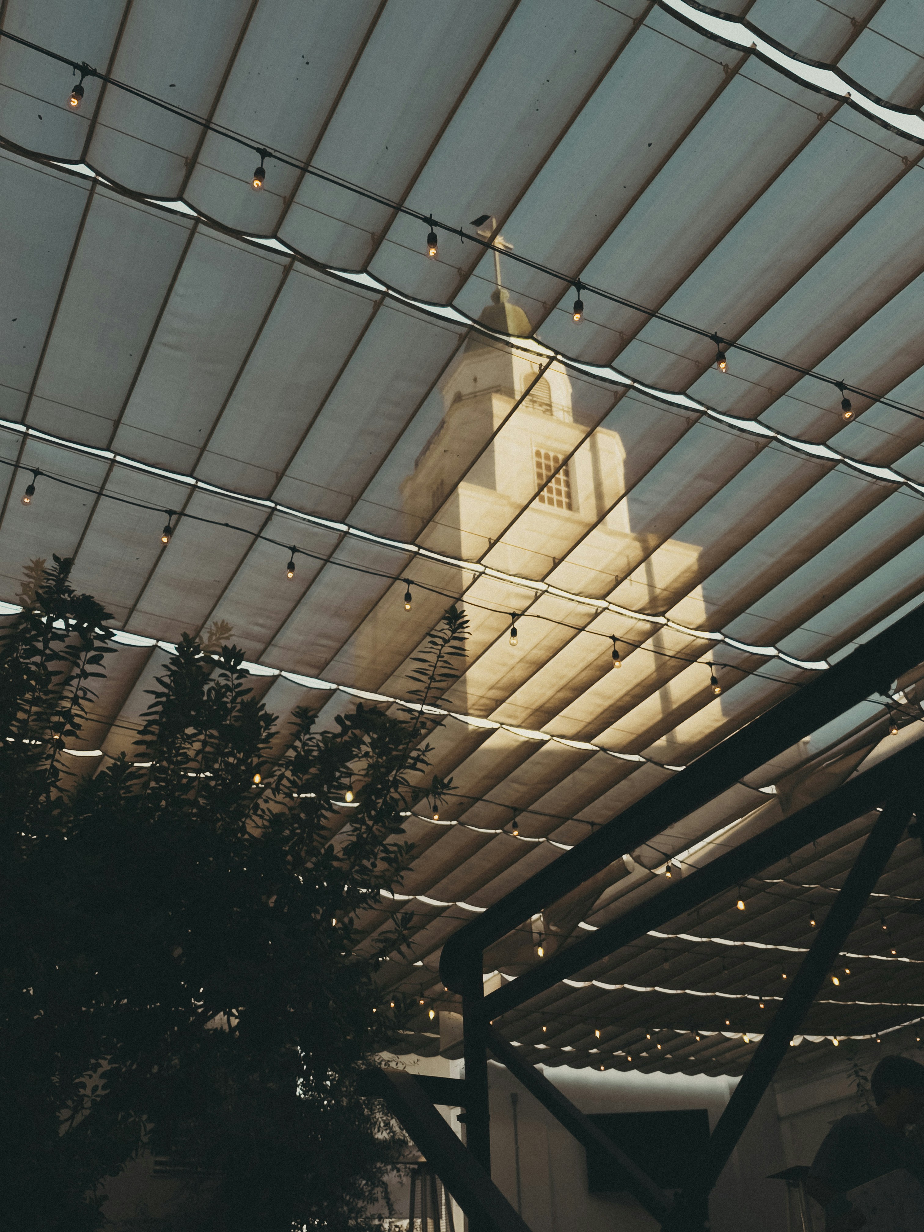 Light-strung Roof Revealing a Towered Reflection