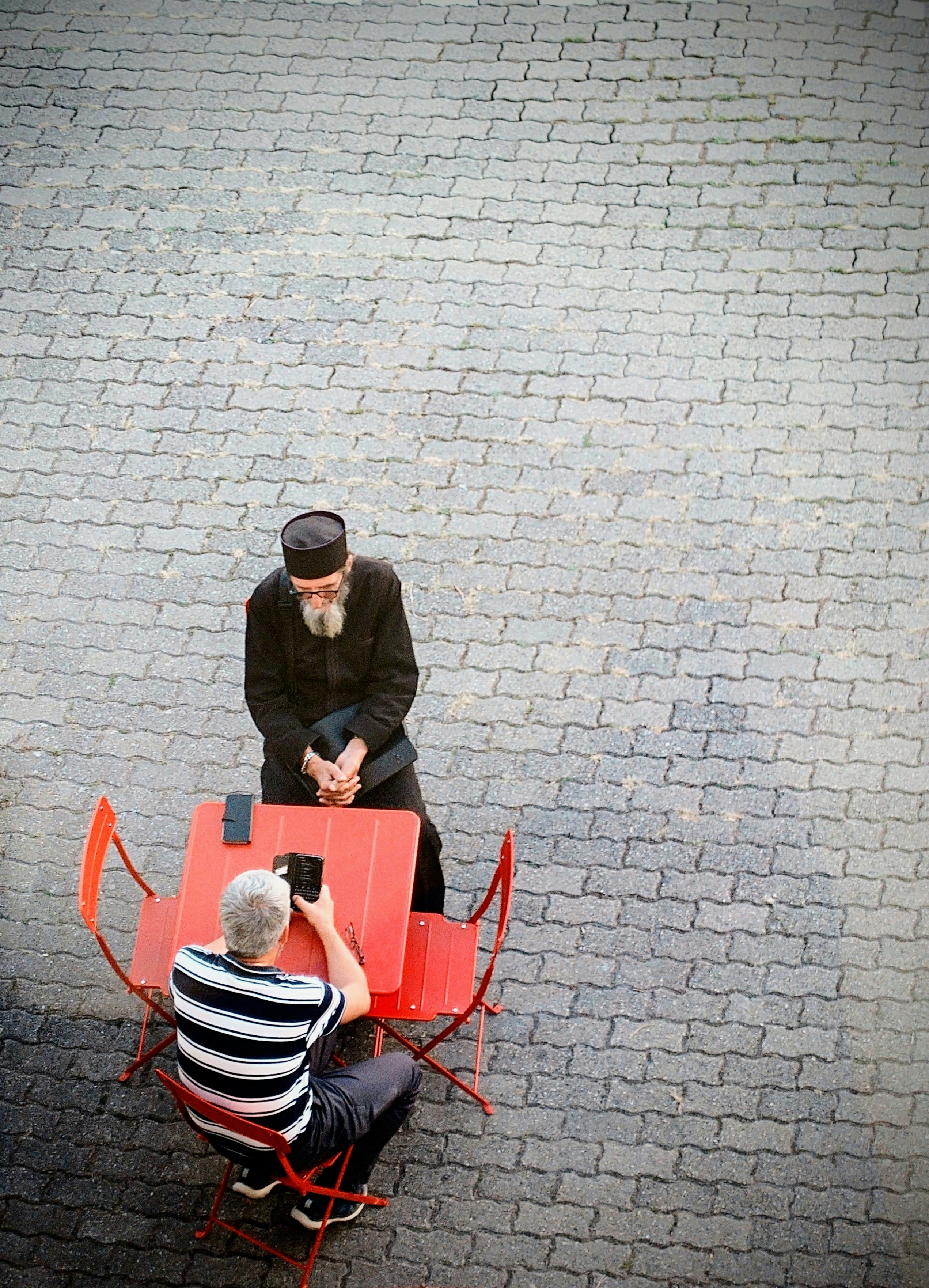 Quiet Exchange at a Crimson Table