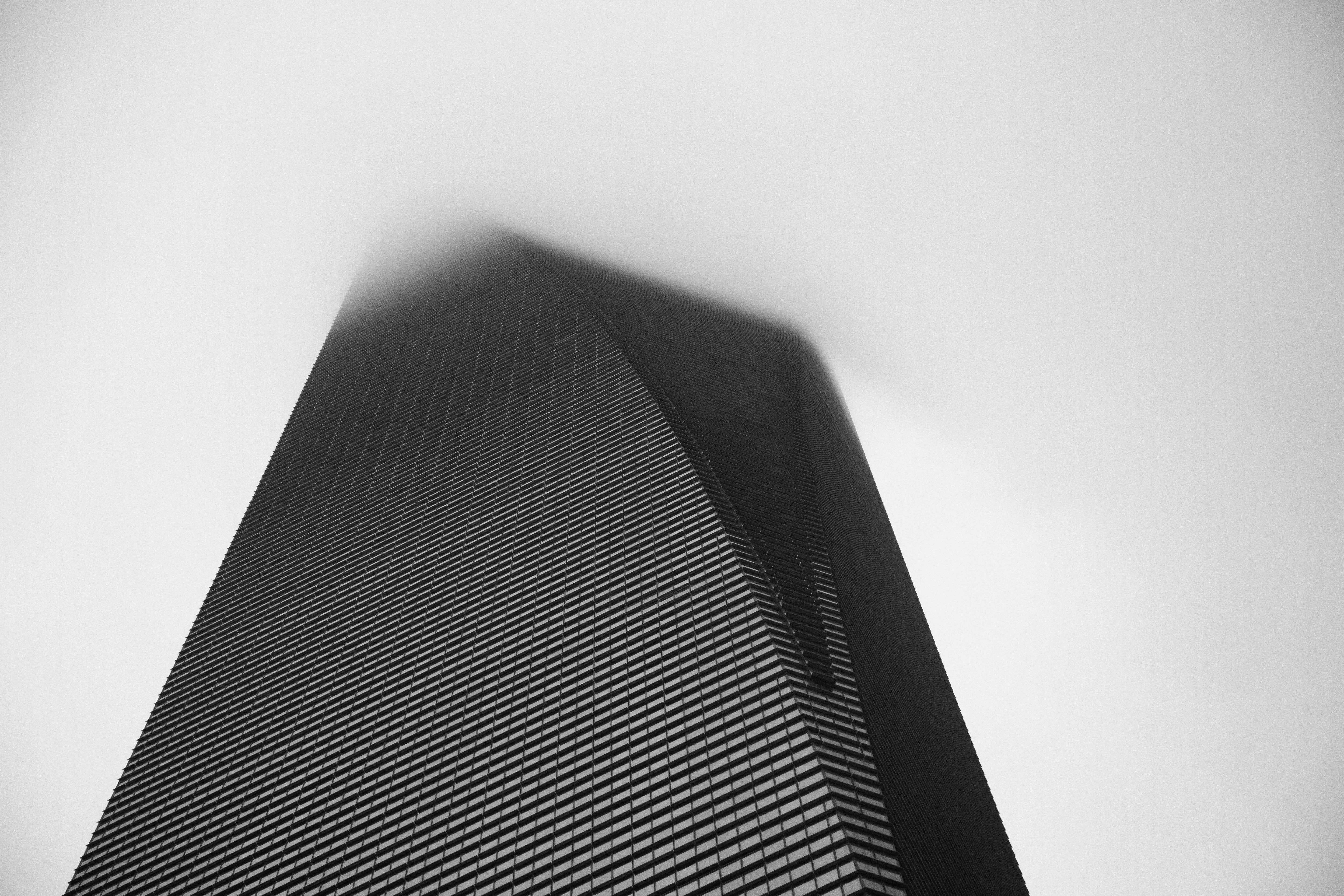 Apextower in the Mist: A Leaning Skyward Monolith Shrouded in Cloud