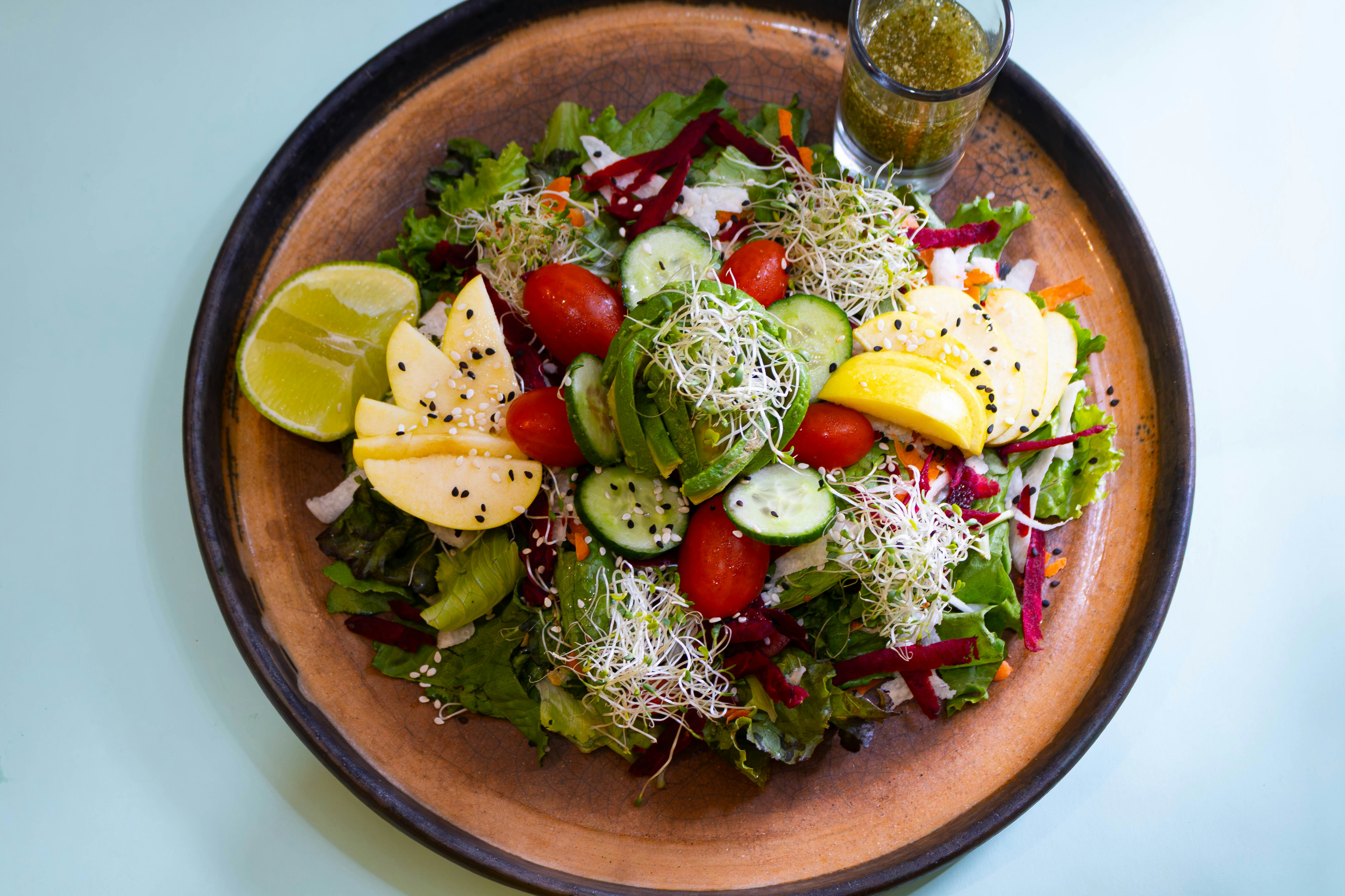 Vibrant Garden Bowl: A Medley of Fresh Greens, Tomatoes, and Citrus