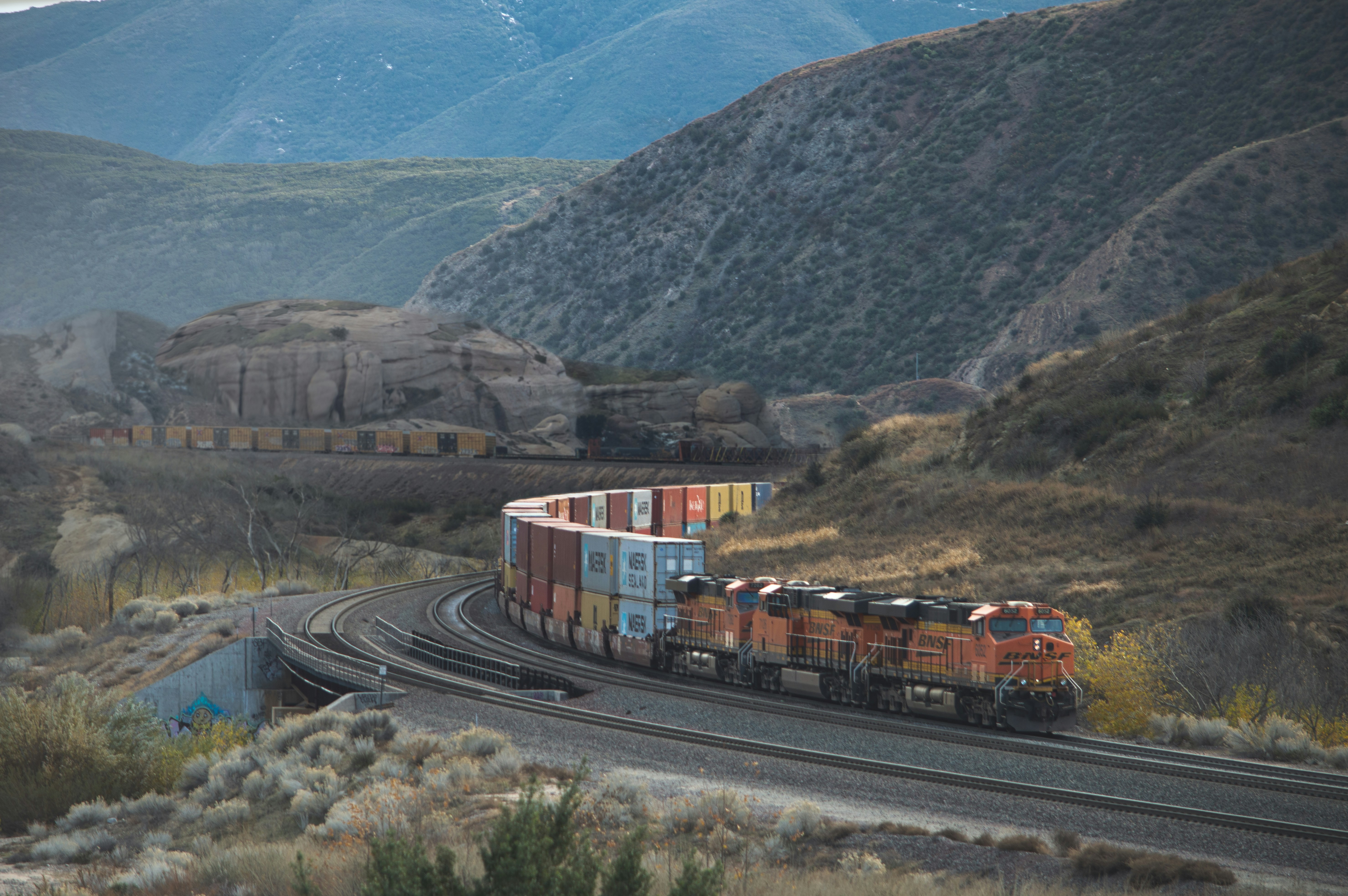 Container Train Winding Through a Desert Gorge