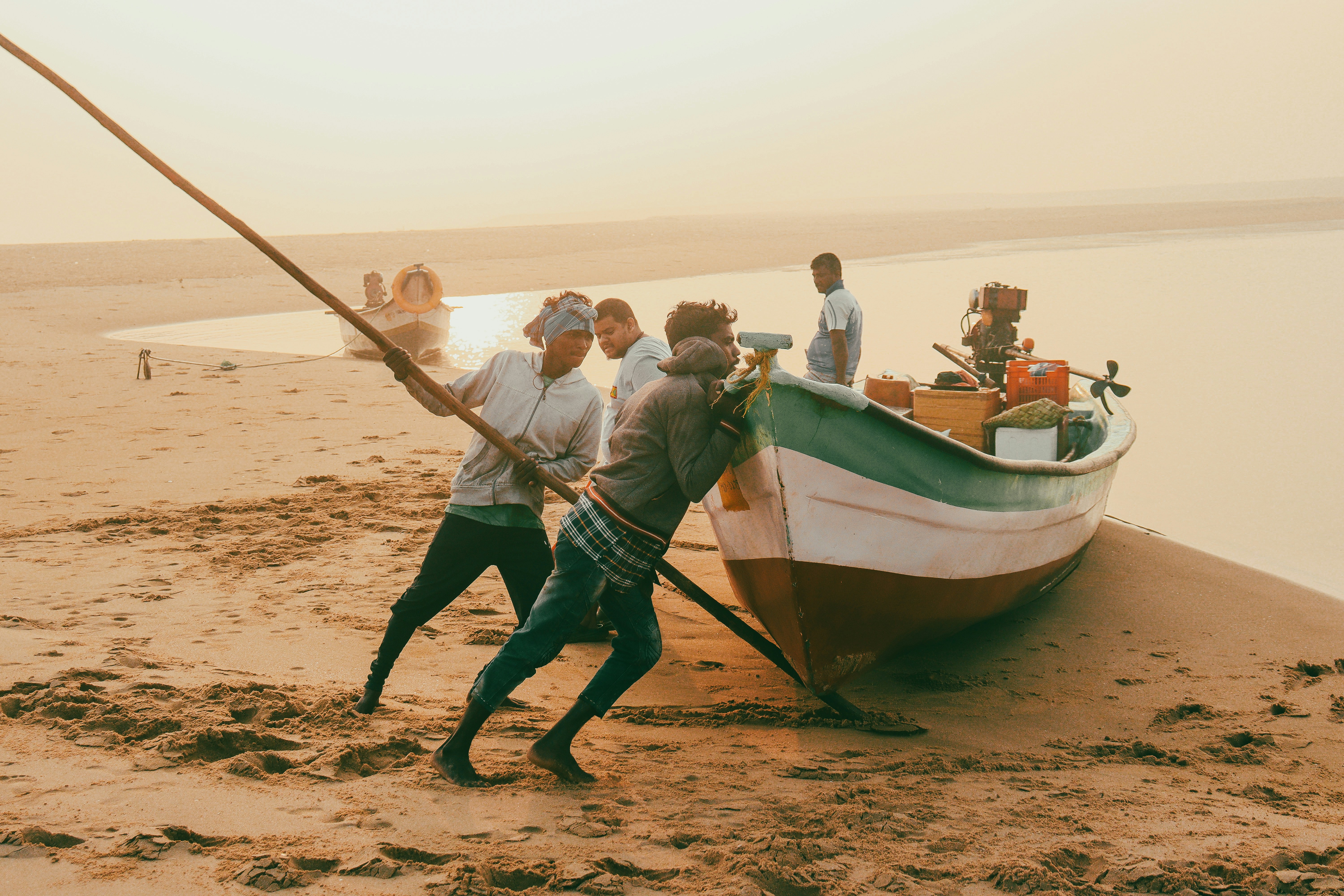 Towline on the Tidal Strait: A Crew Pulls the Boat Inland at Sunset