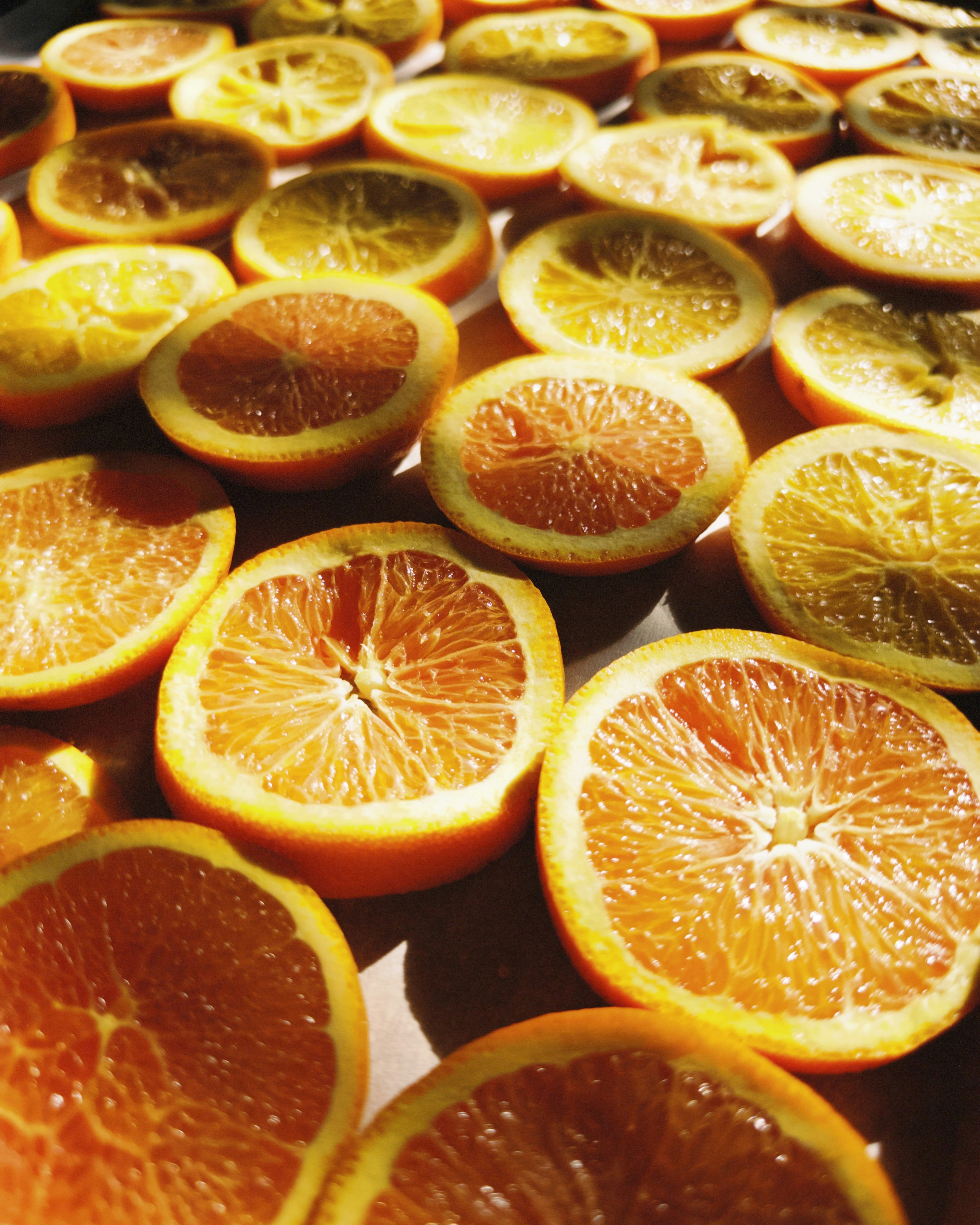 Citrus Mosaic: A Sea of Halved Oranges Under Sunlit Light