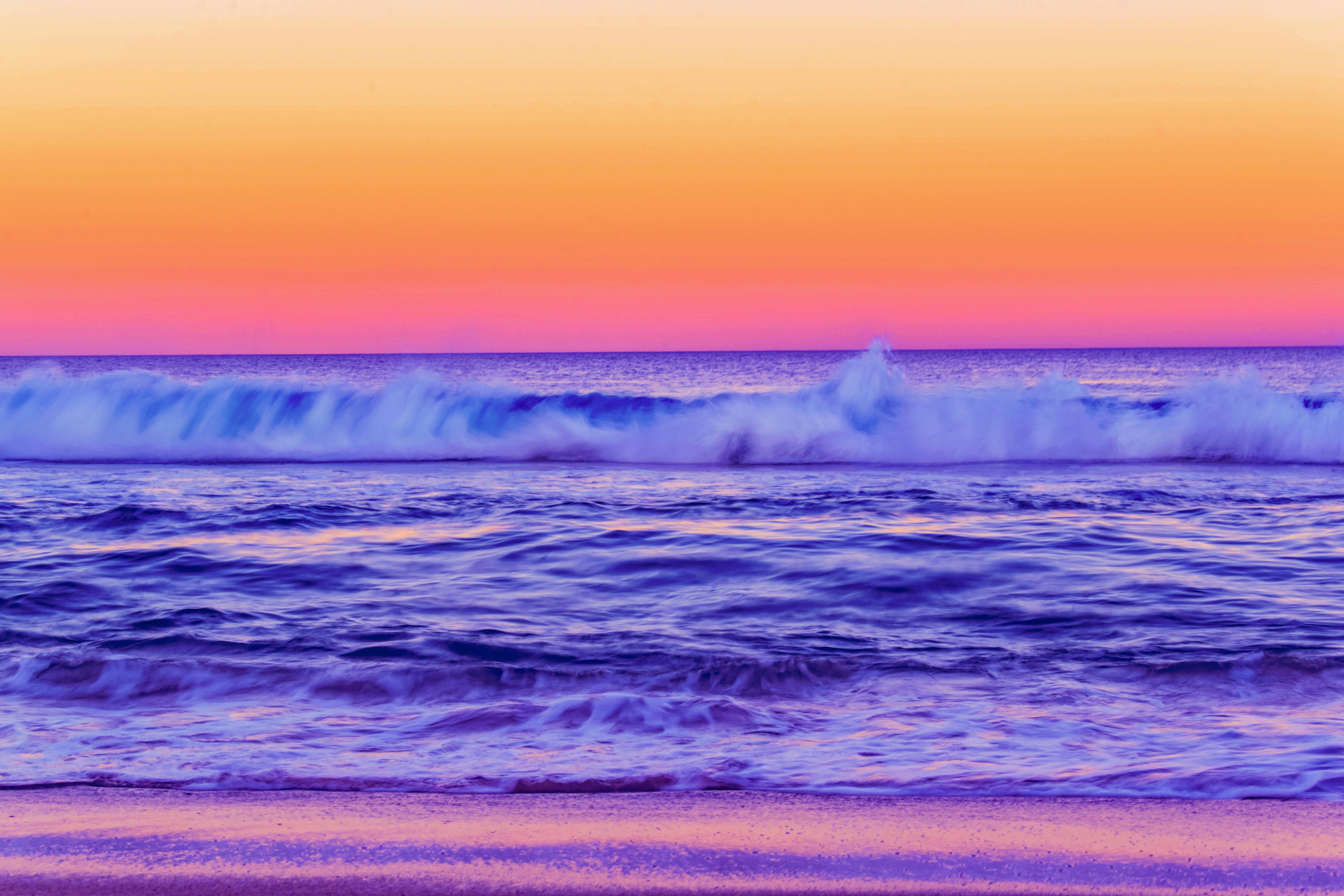 Tide Neon: Coral Horizon over Quiet Surf