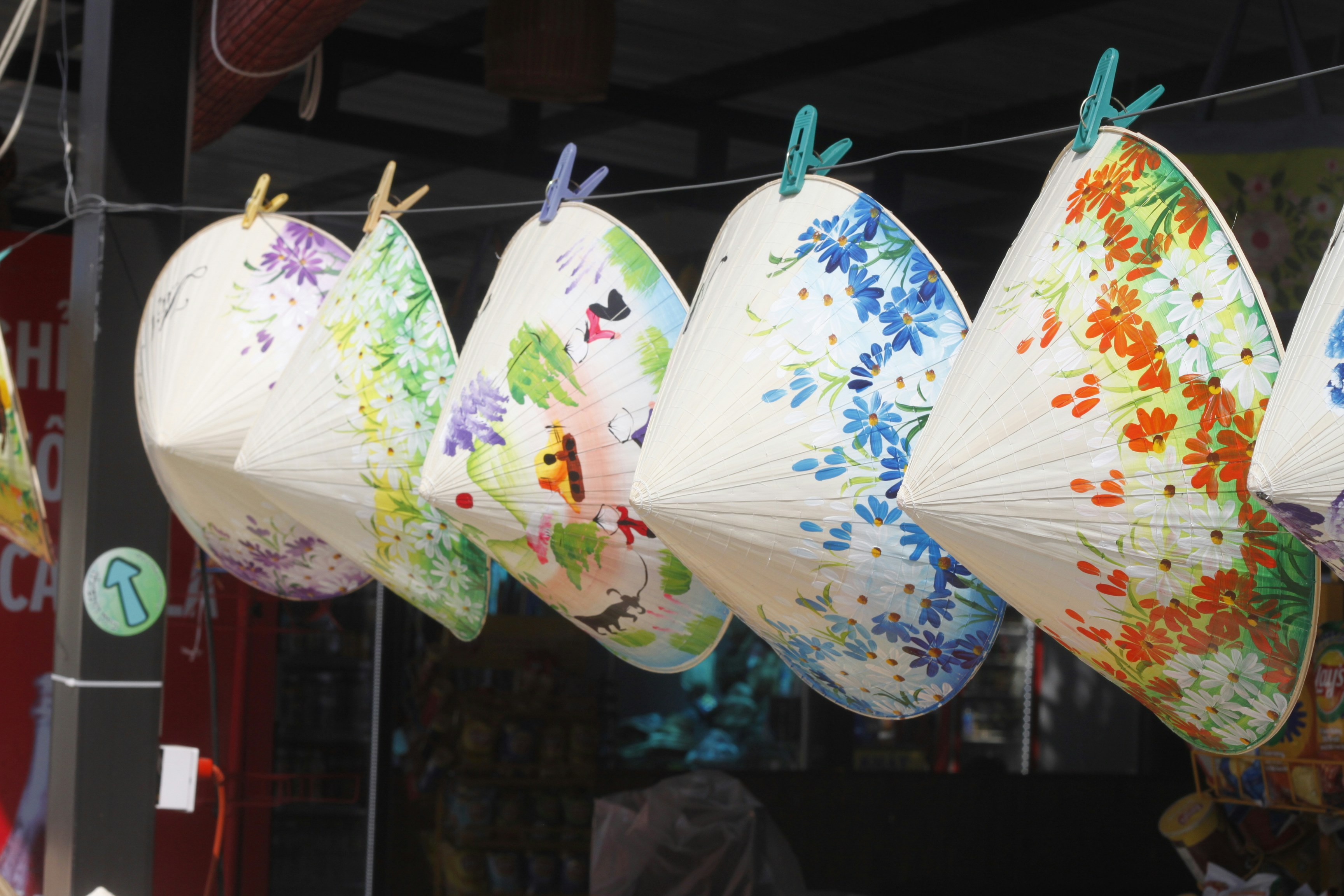 Vibrant row of painted paper lanterns on a shop line