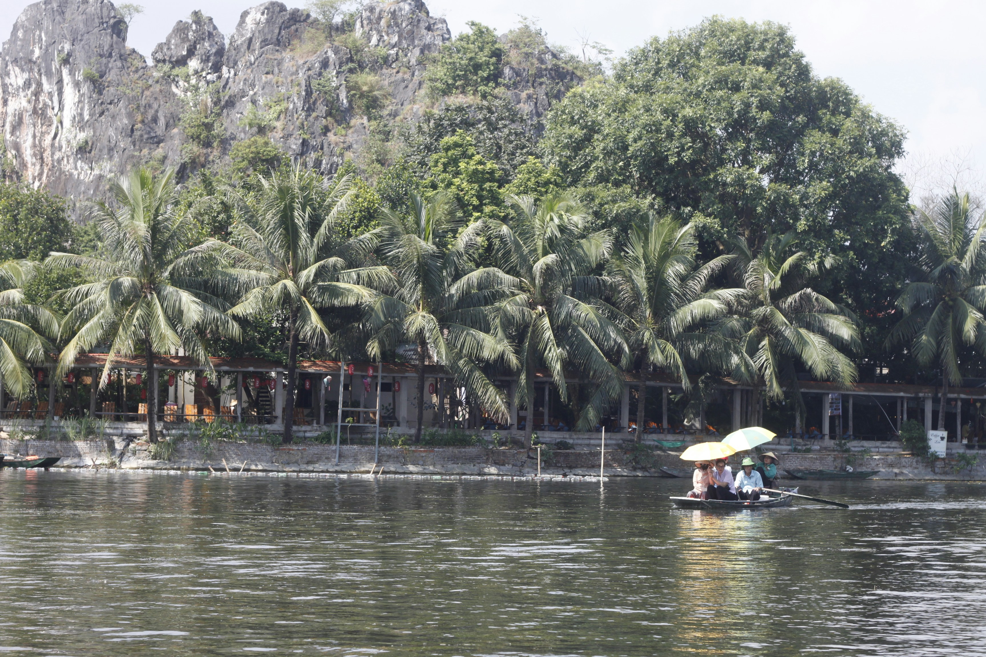 Canopied Riverside Ferry on a Calm Waterway