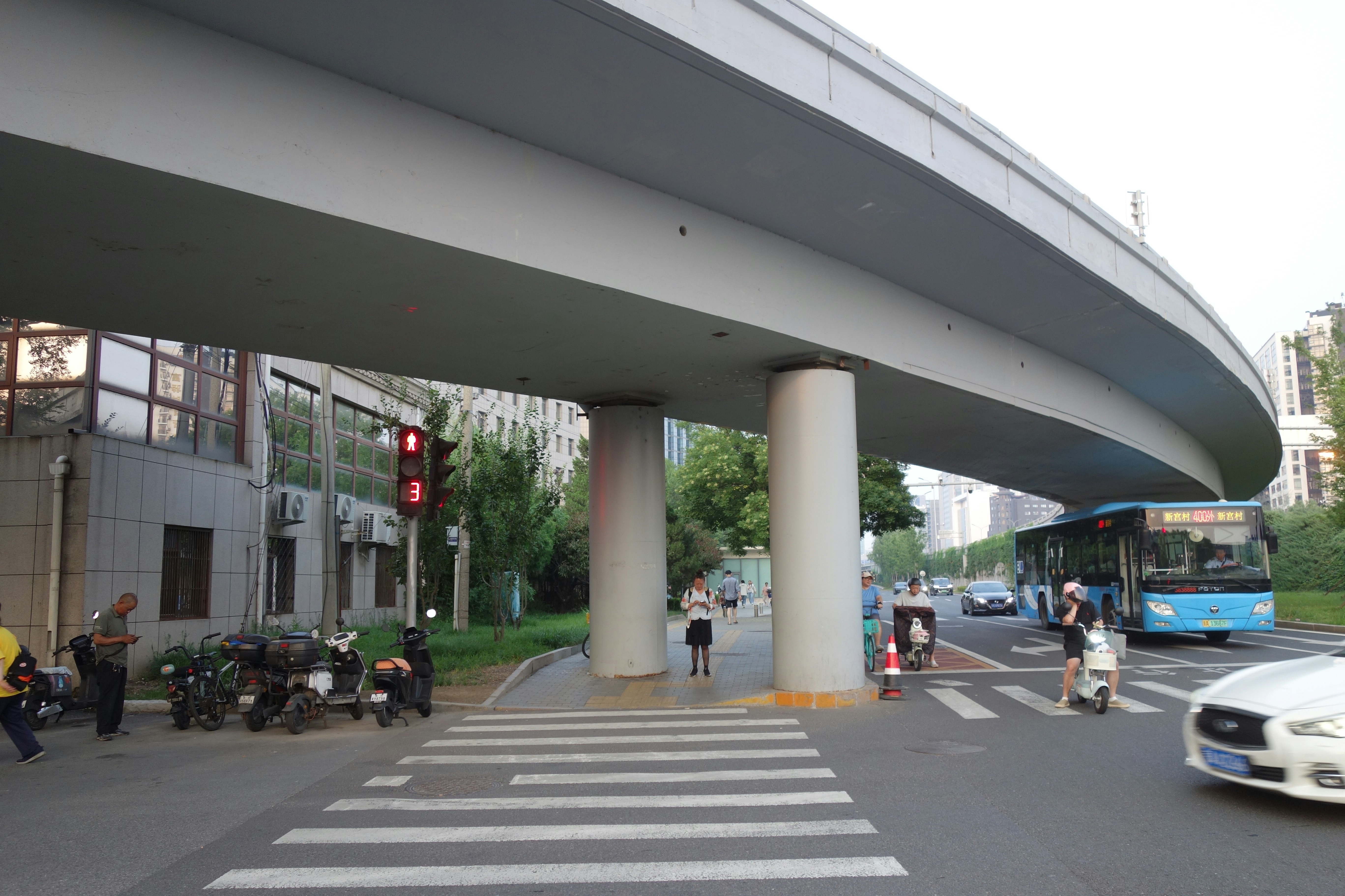 Under the Curve: People Crossing Beneath a City Overpass