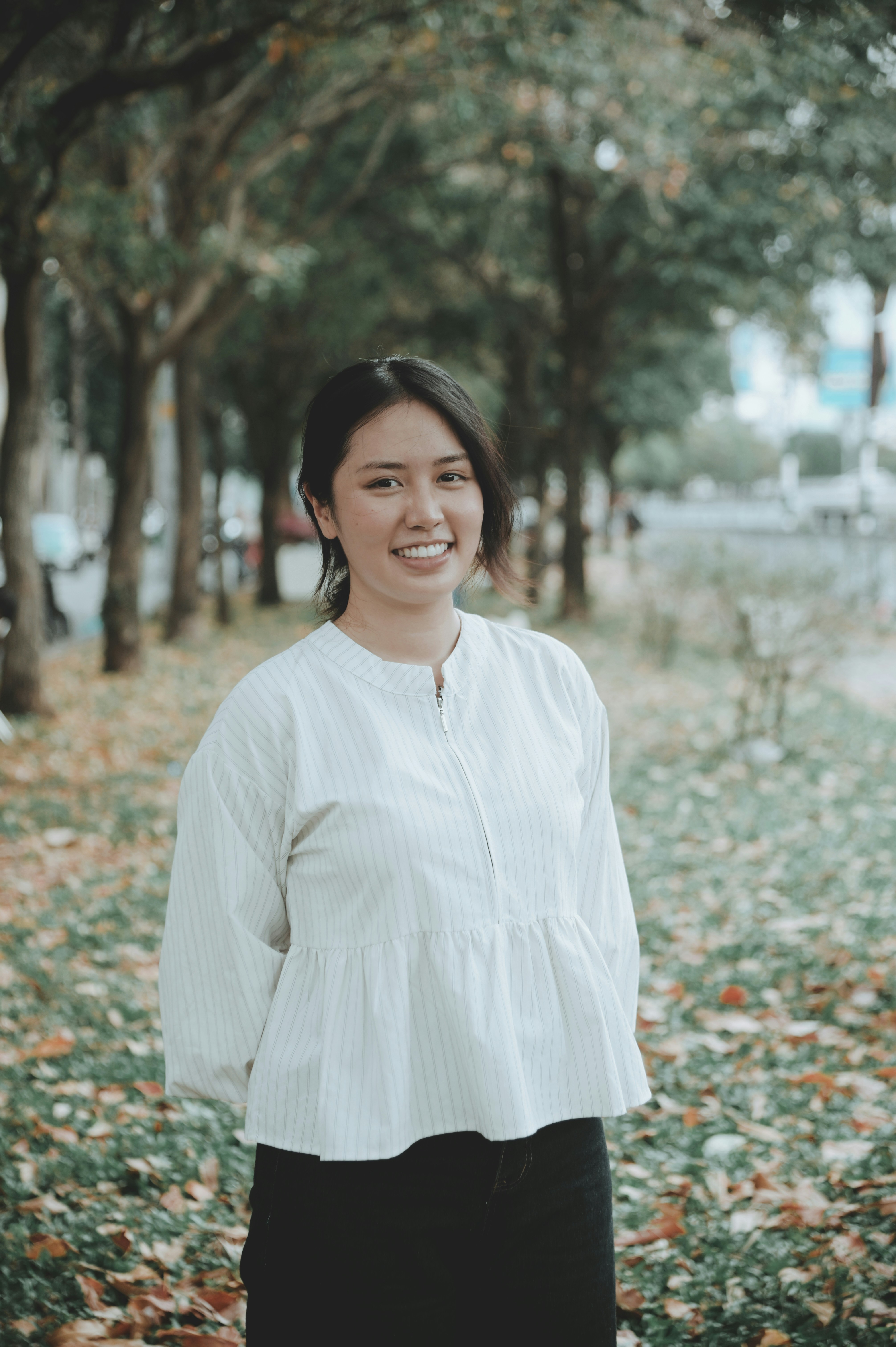 Autumn Avenue Portrait: Quiet Confidence along a Leaf-Littered Path